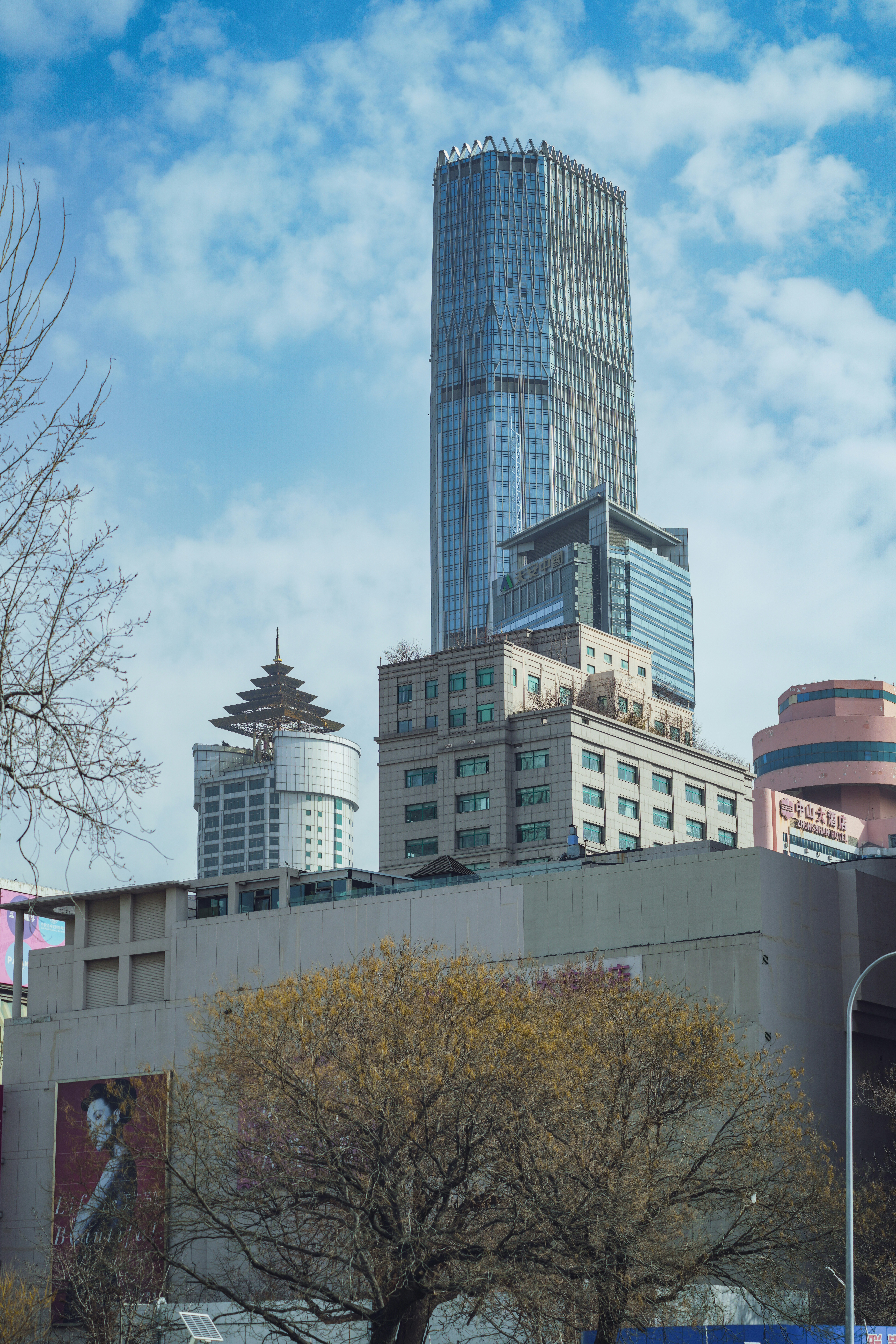 Crown of Glass: The Skyward Tower Over a Layered Cityscape