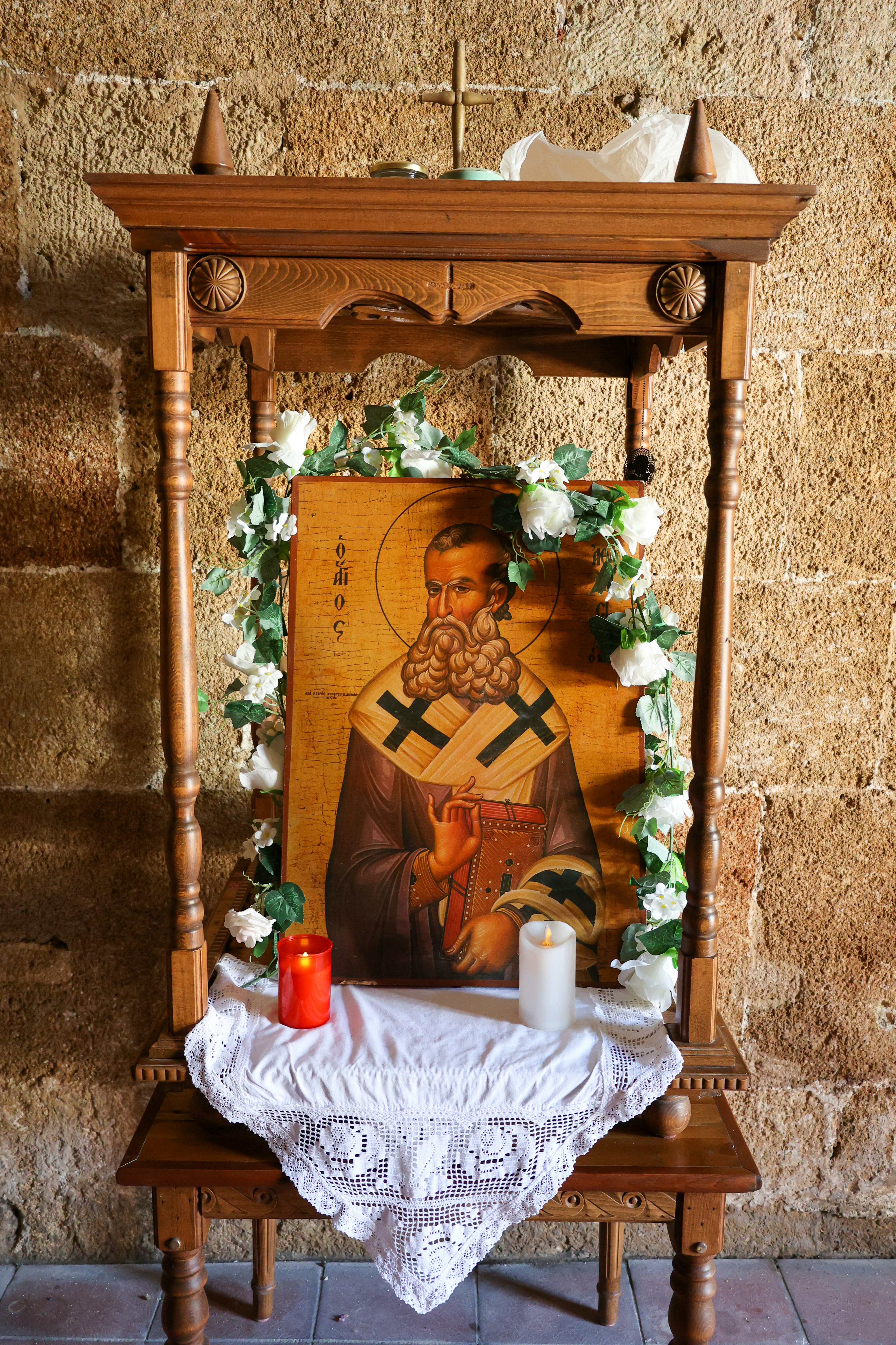 Icon on a Wooden Altar: A Sacred Icon Framed by Floral Garlands