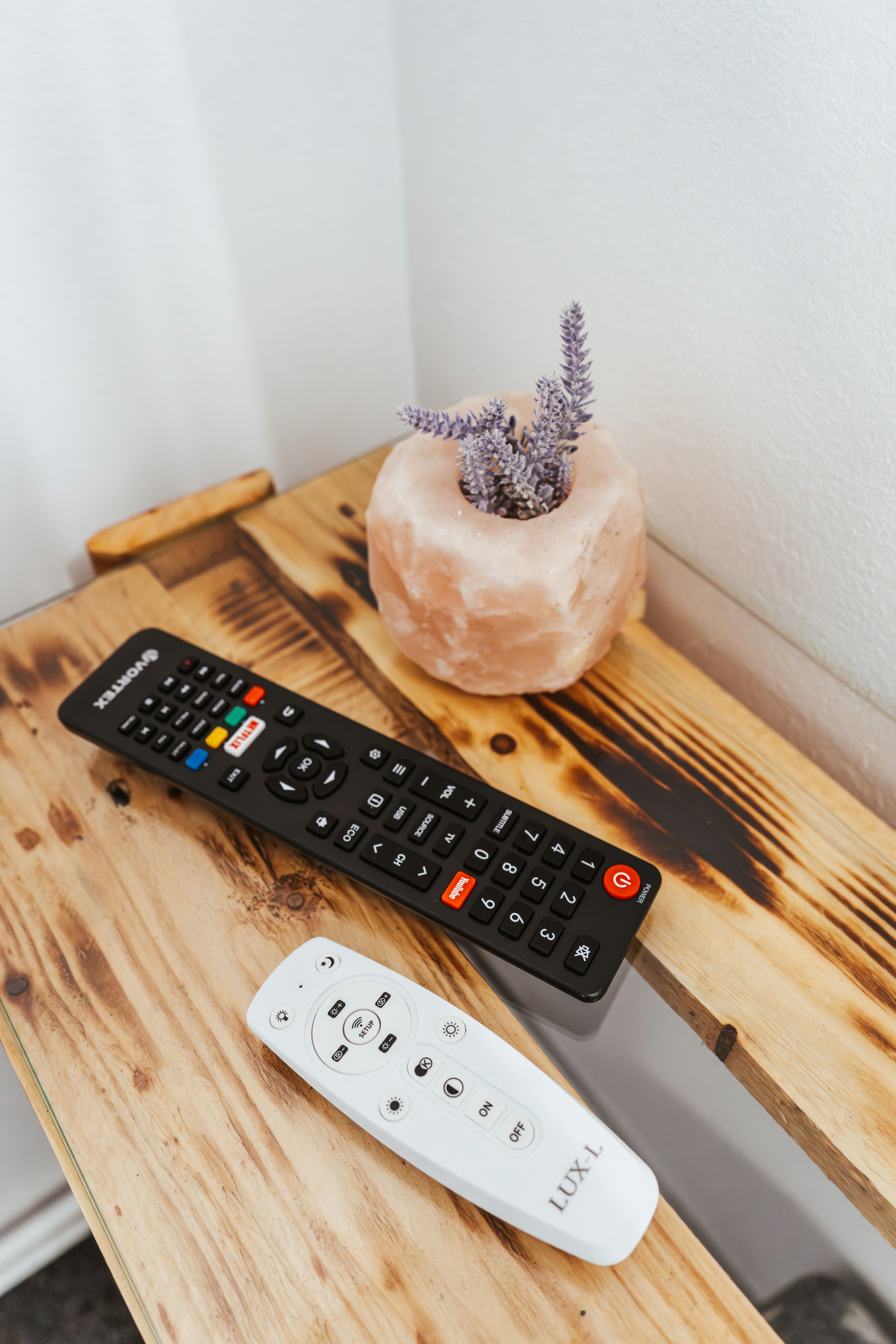 A remote control sitting on top of a wooden table photo – Free ...