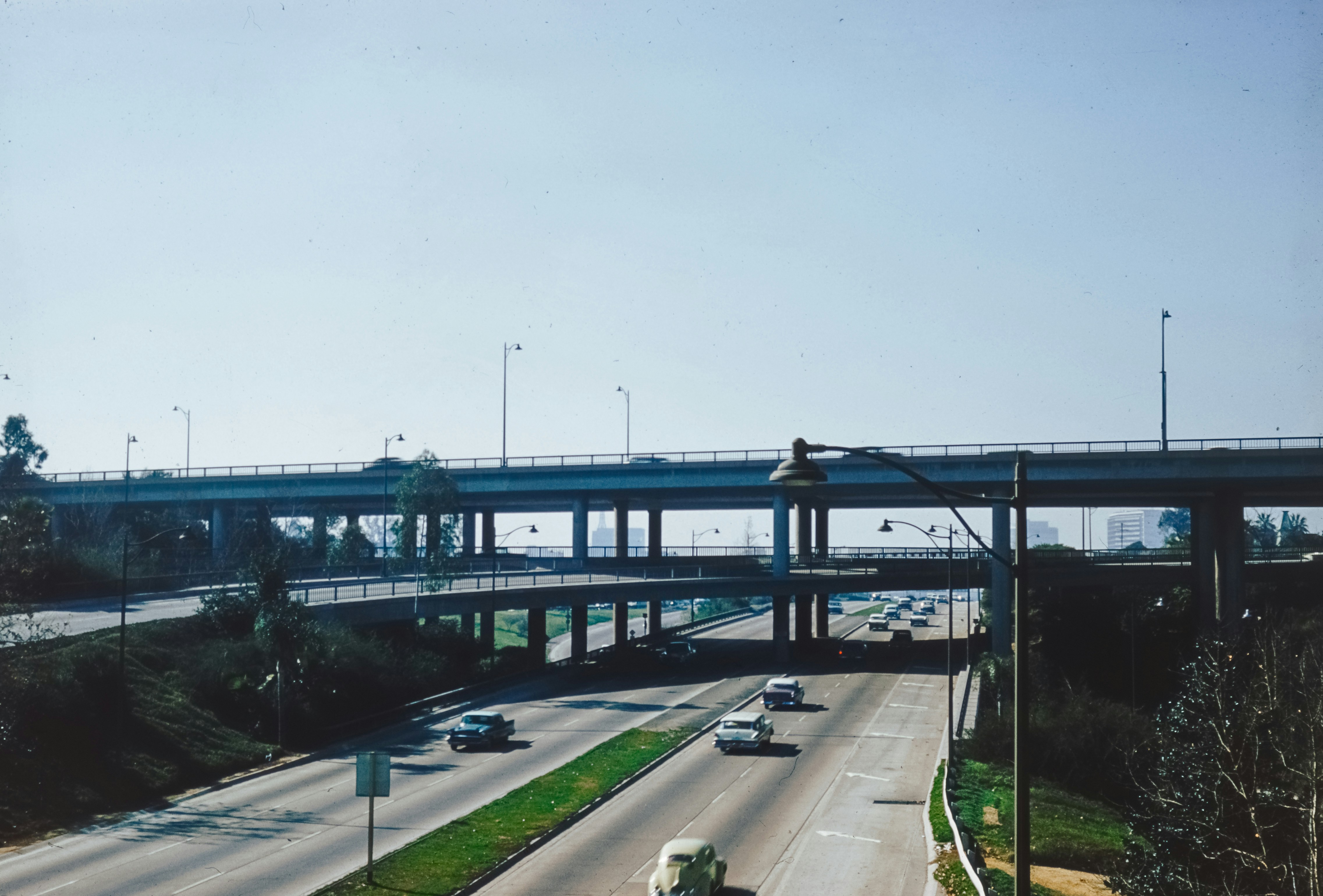 A view of a highway with a bridge in the background photo – Free ...