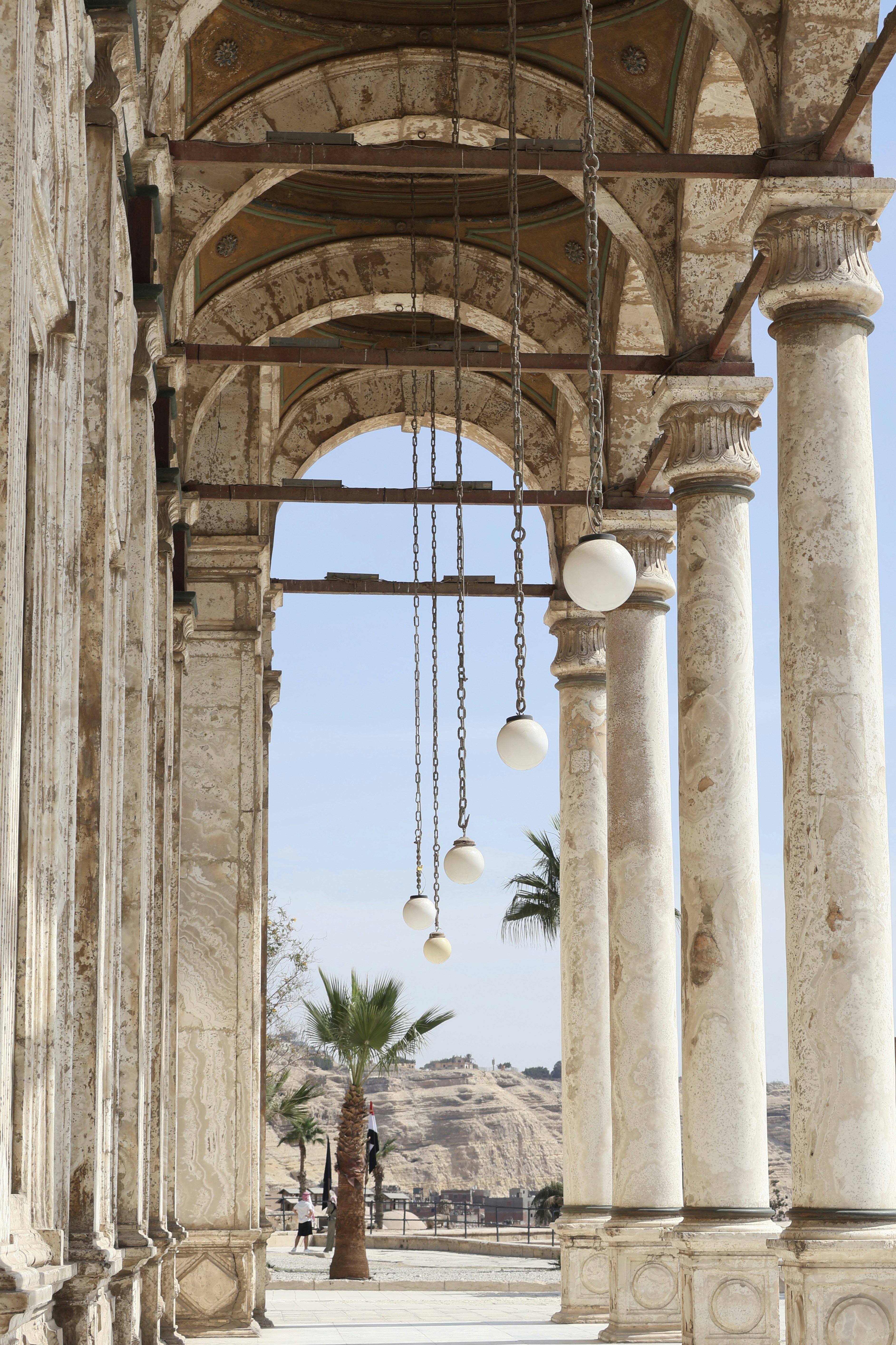 Echoes of Stone and Light: Hanging Globes in a Desert Colonnade