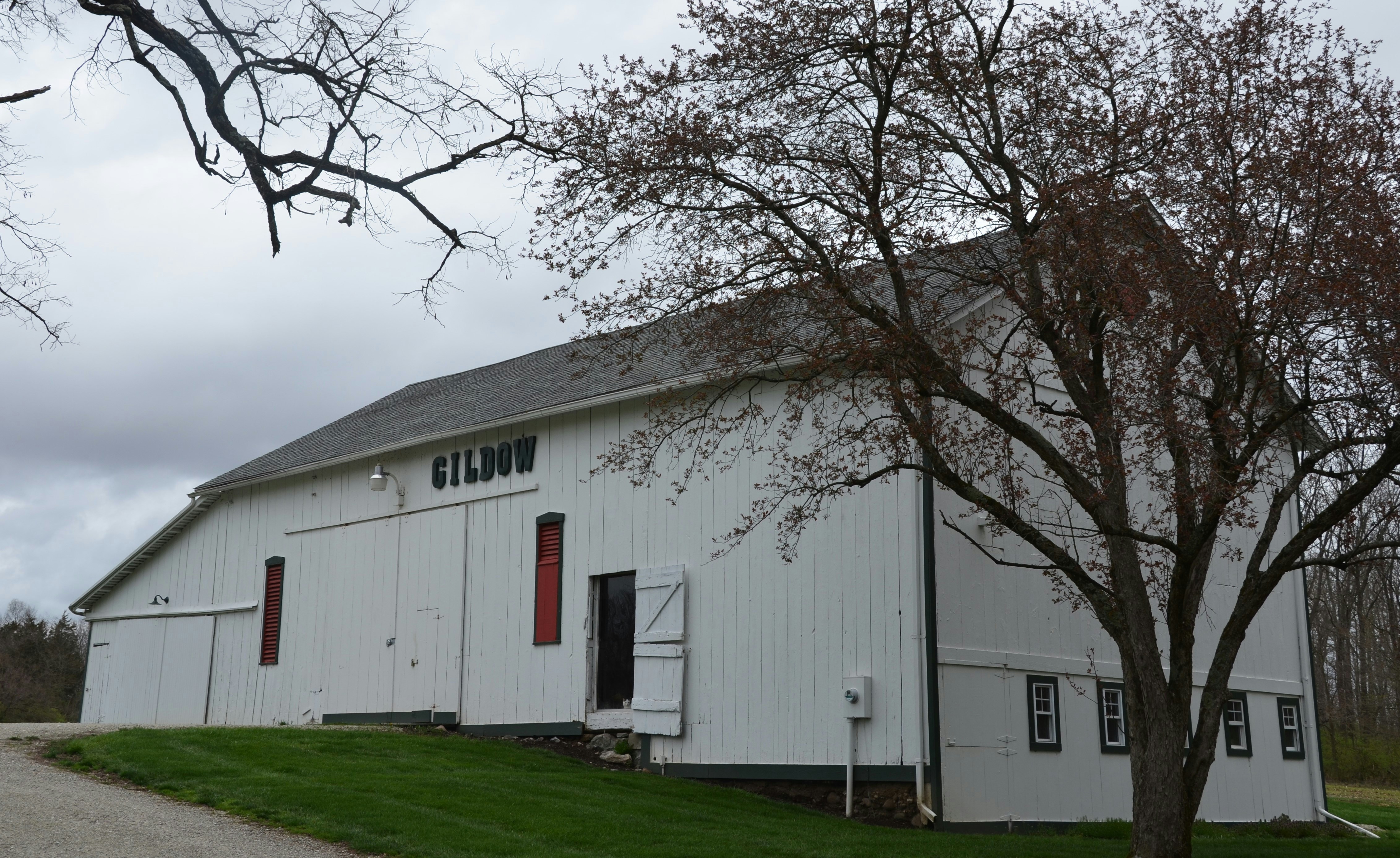 A large white barn with a red door and windows photo – Free Outdoors ...