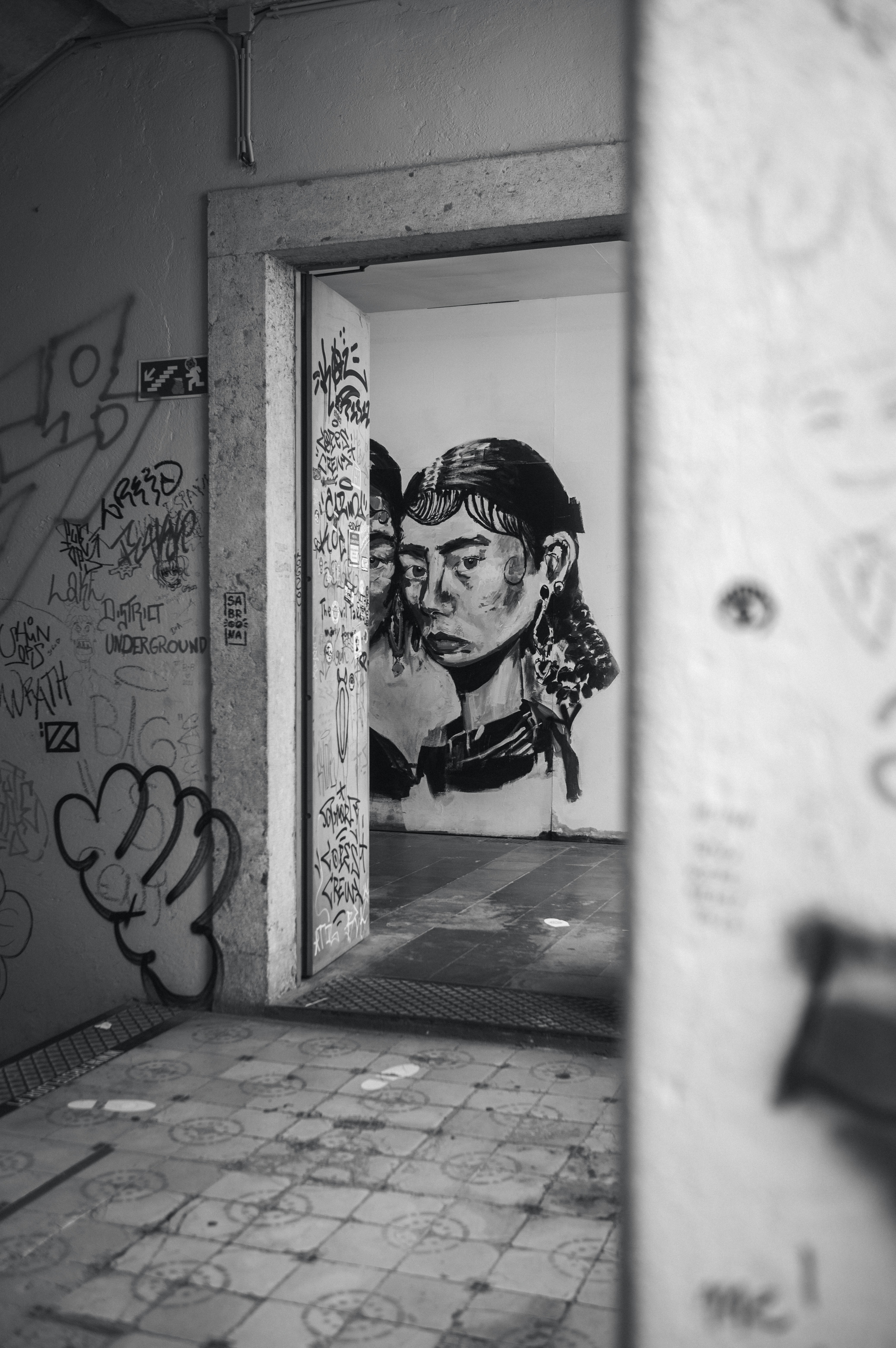 Threshold Portrait: A Graffiti Corridor Framing a Dominant Mural