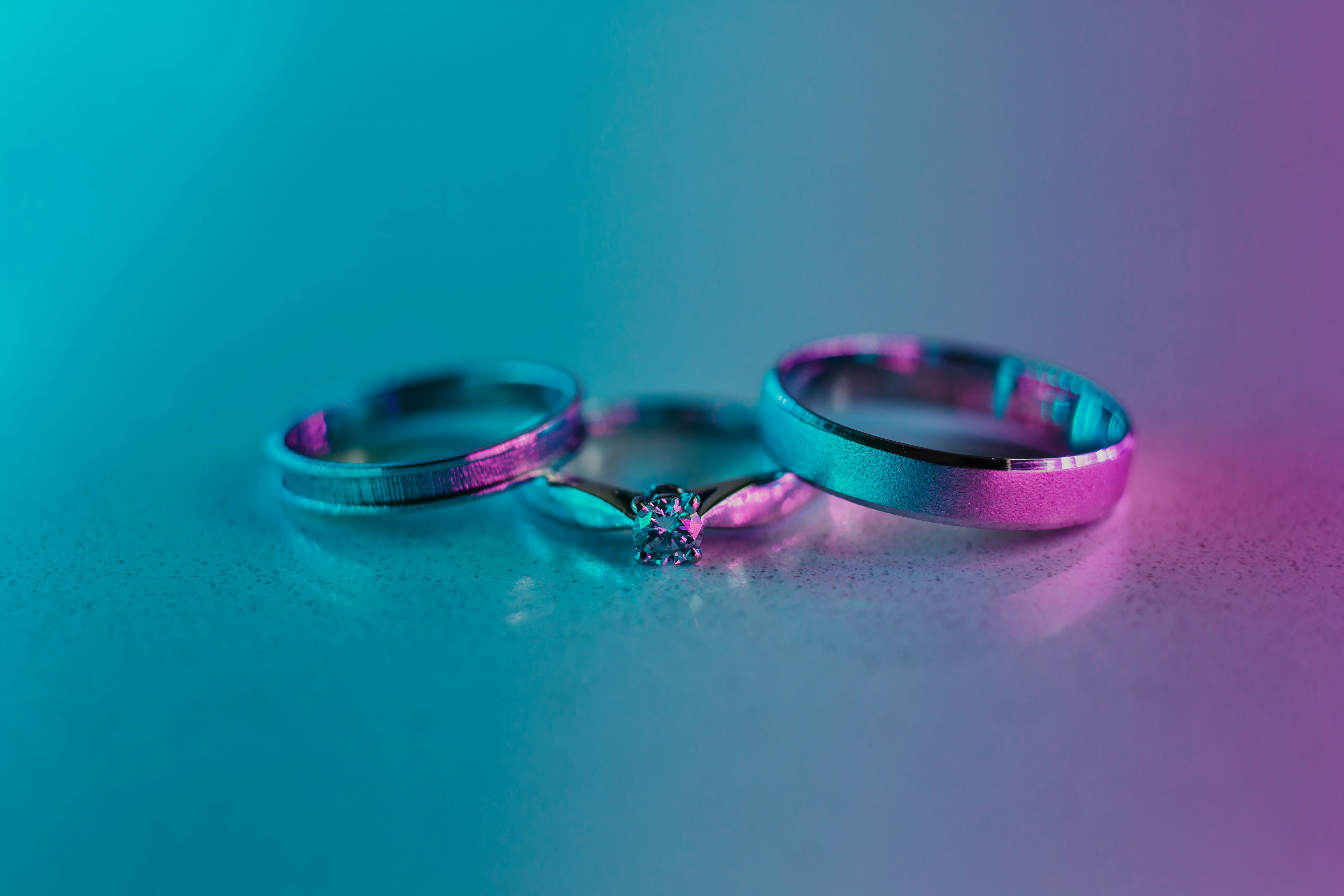 A couple of wedding rings sitting on top of a table photo – Free ...