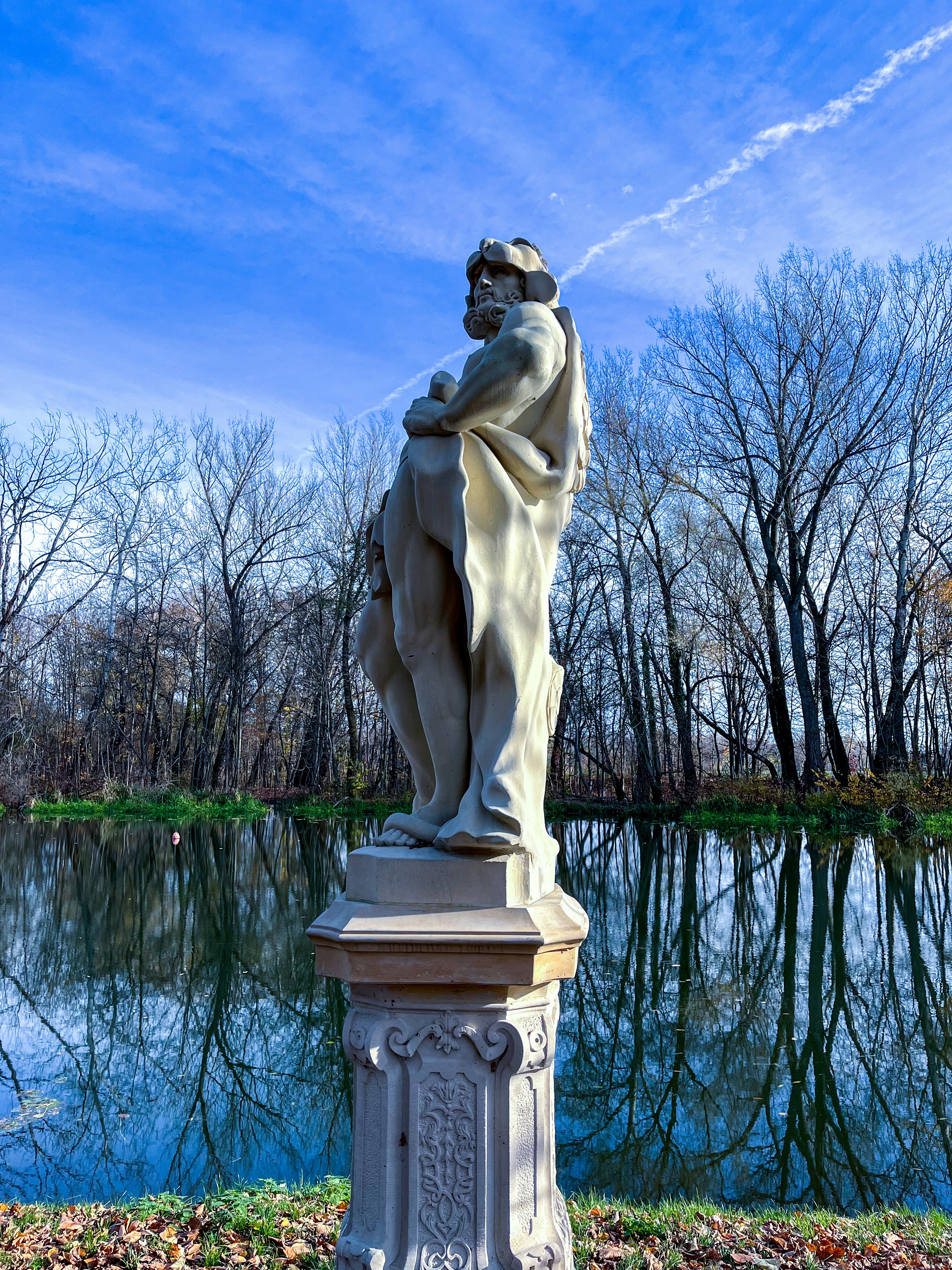 Marble Sentinel by the Quiet Pond Under Winter Sky