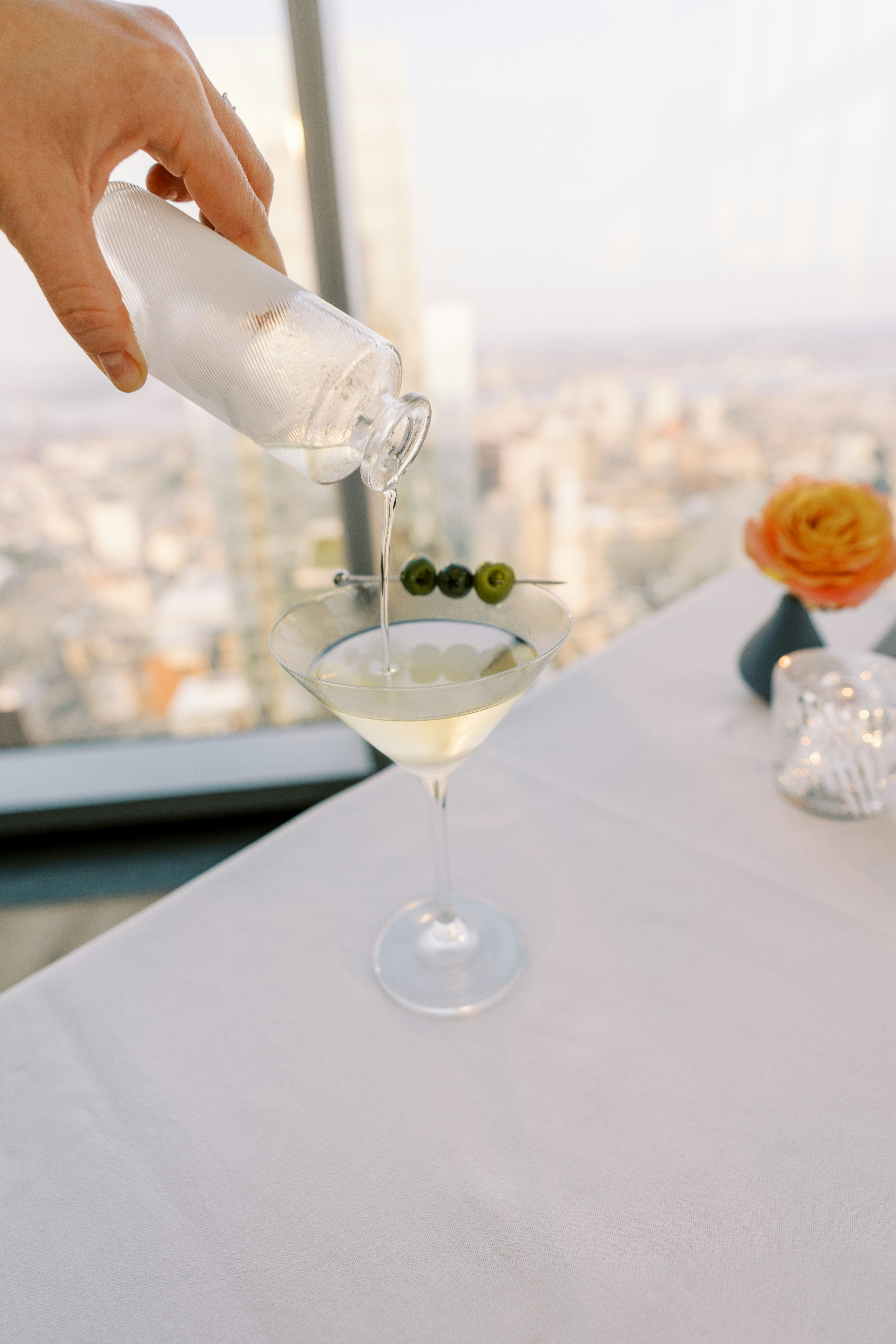 A person pours a drink into a martini glass photo – Free Beige Image on ...