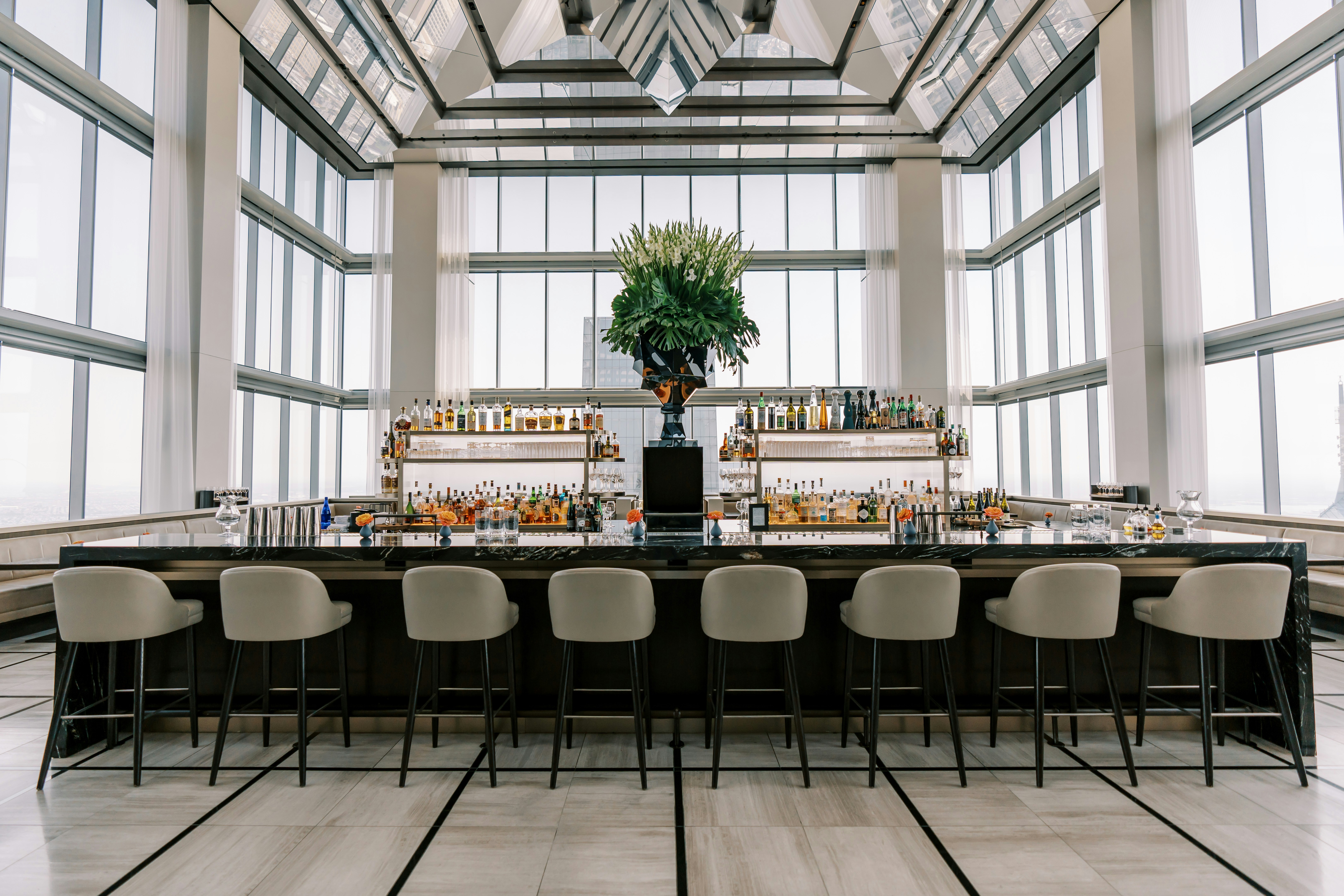 A bar with a bunch of chairs around it photo – Free Bar Image on Unsplash