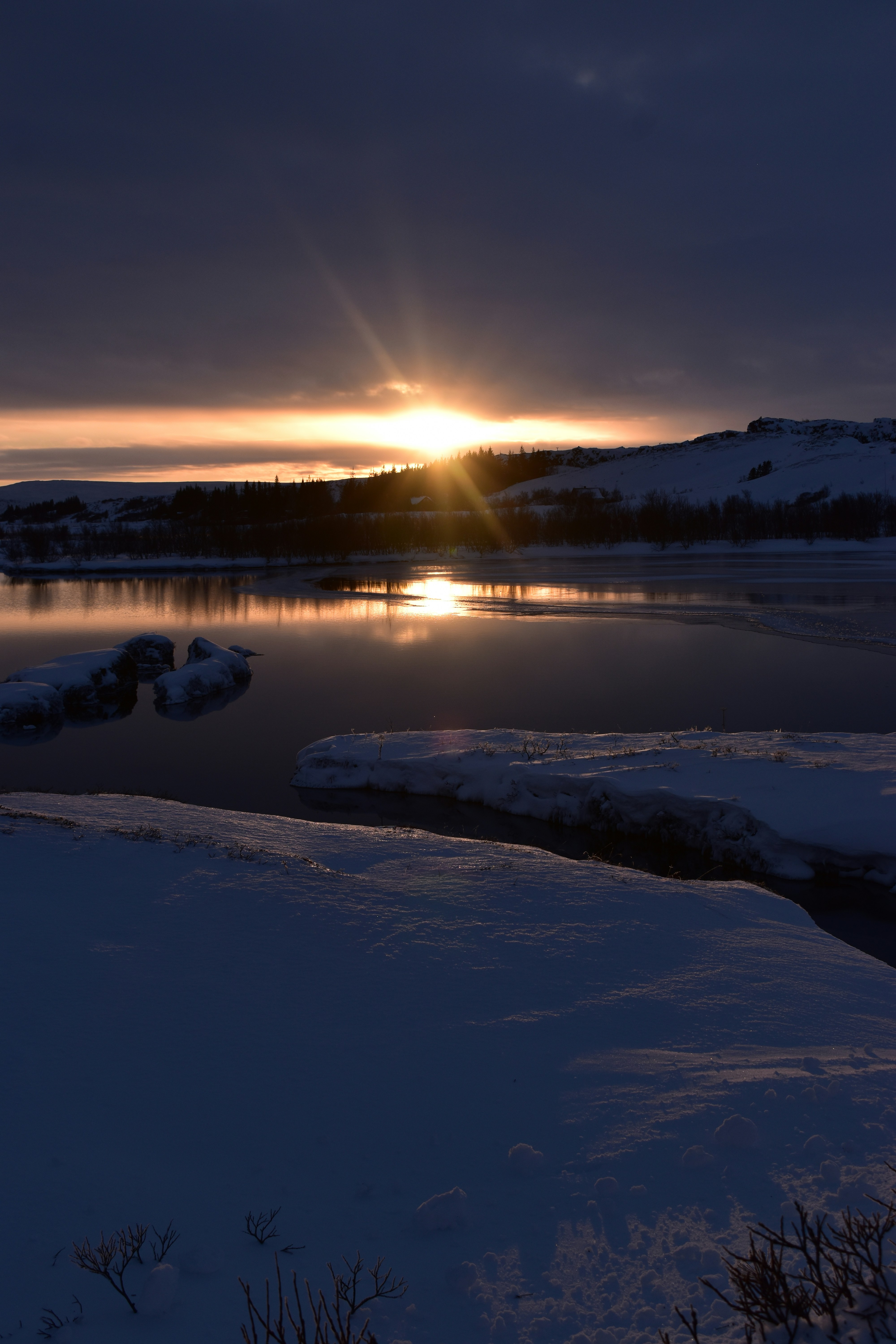 The sun is setting over a lake in the snow photo – Free Iceland Image ...
