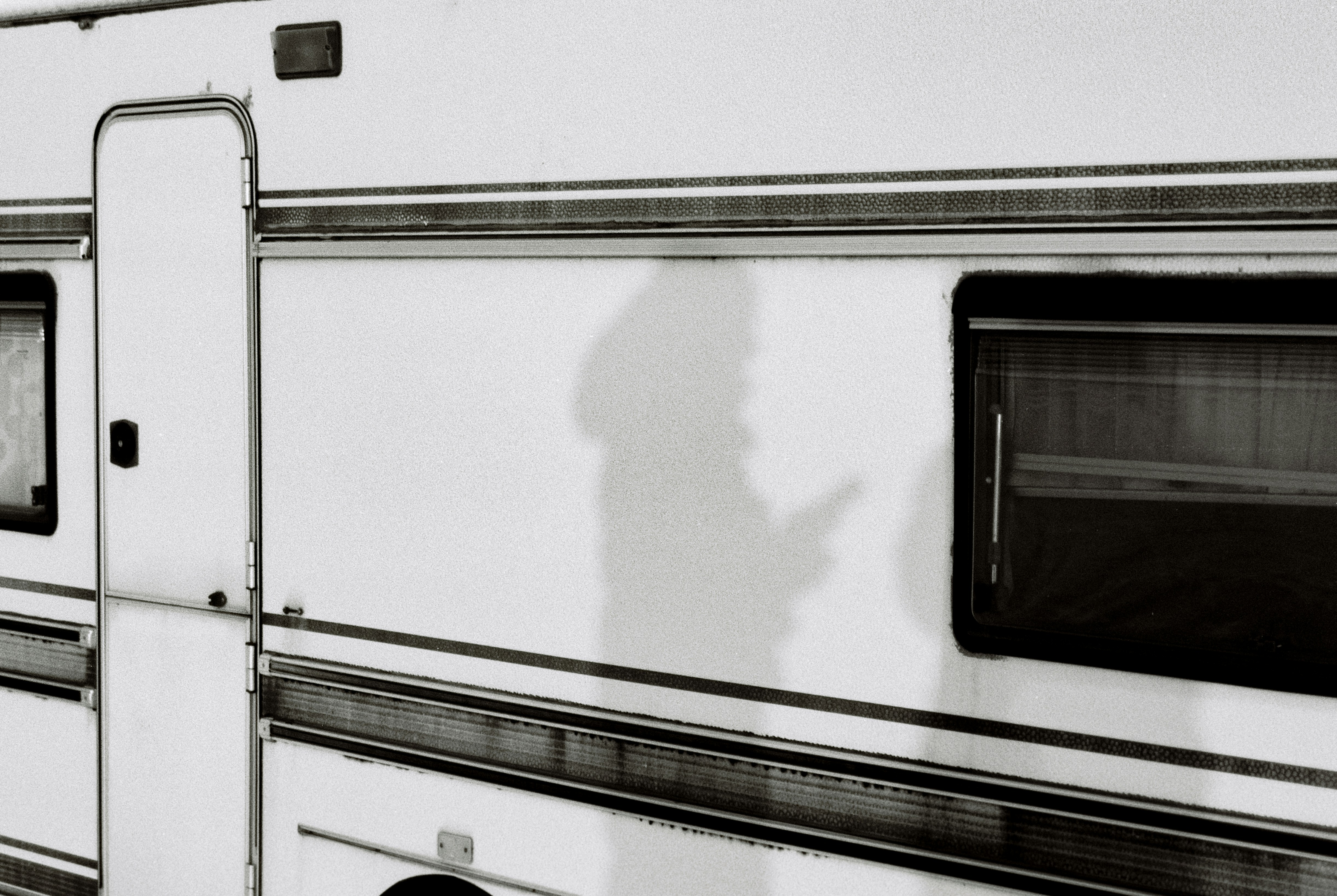A shadow of a person standing in front of a trailer photo – Free ...