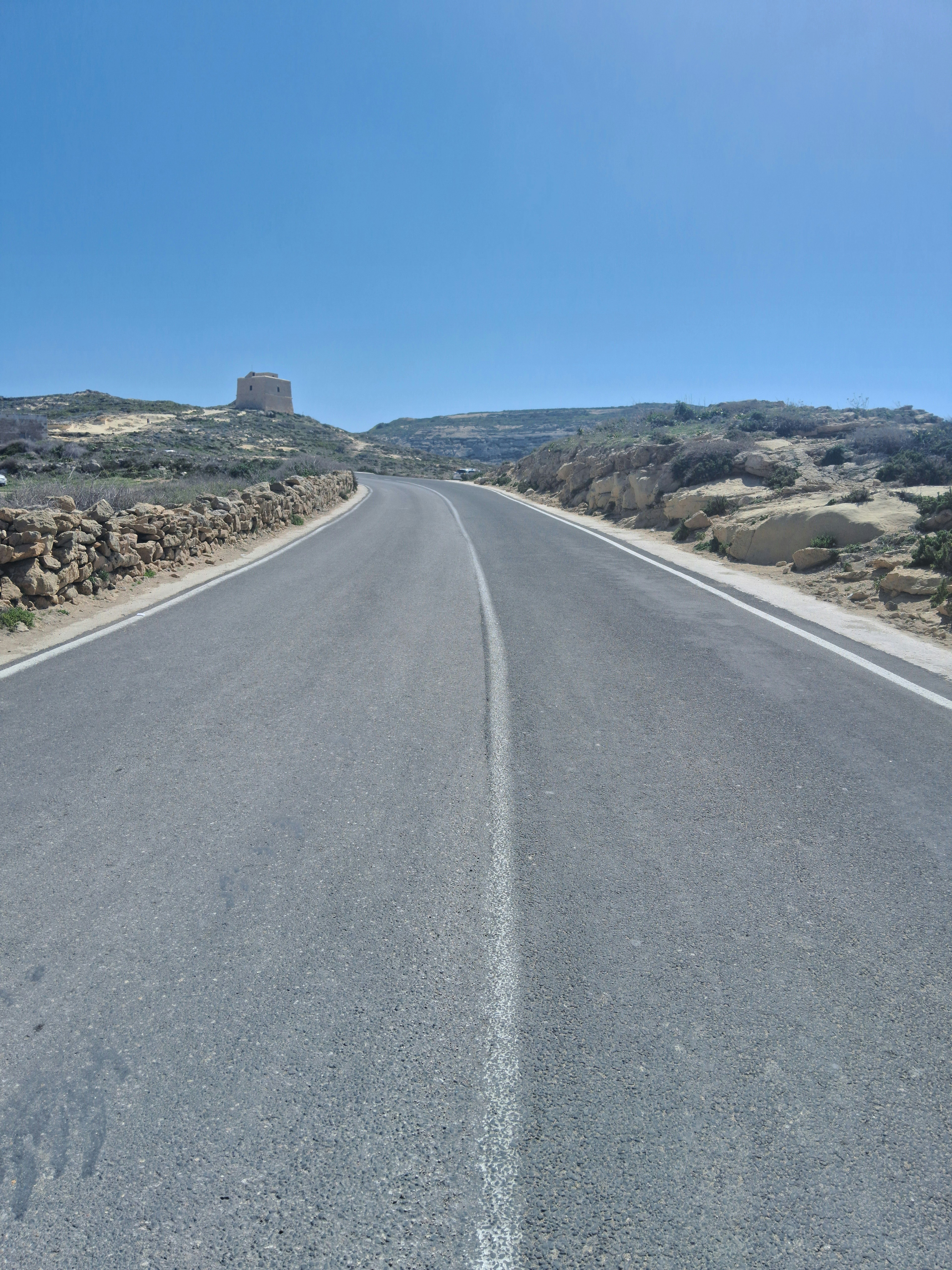 an empty road in the middle of the desert