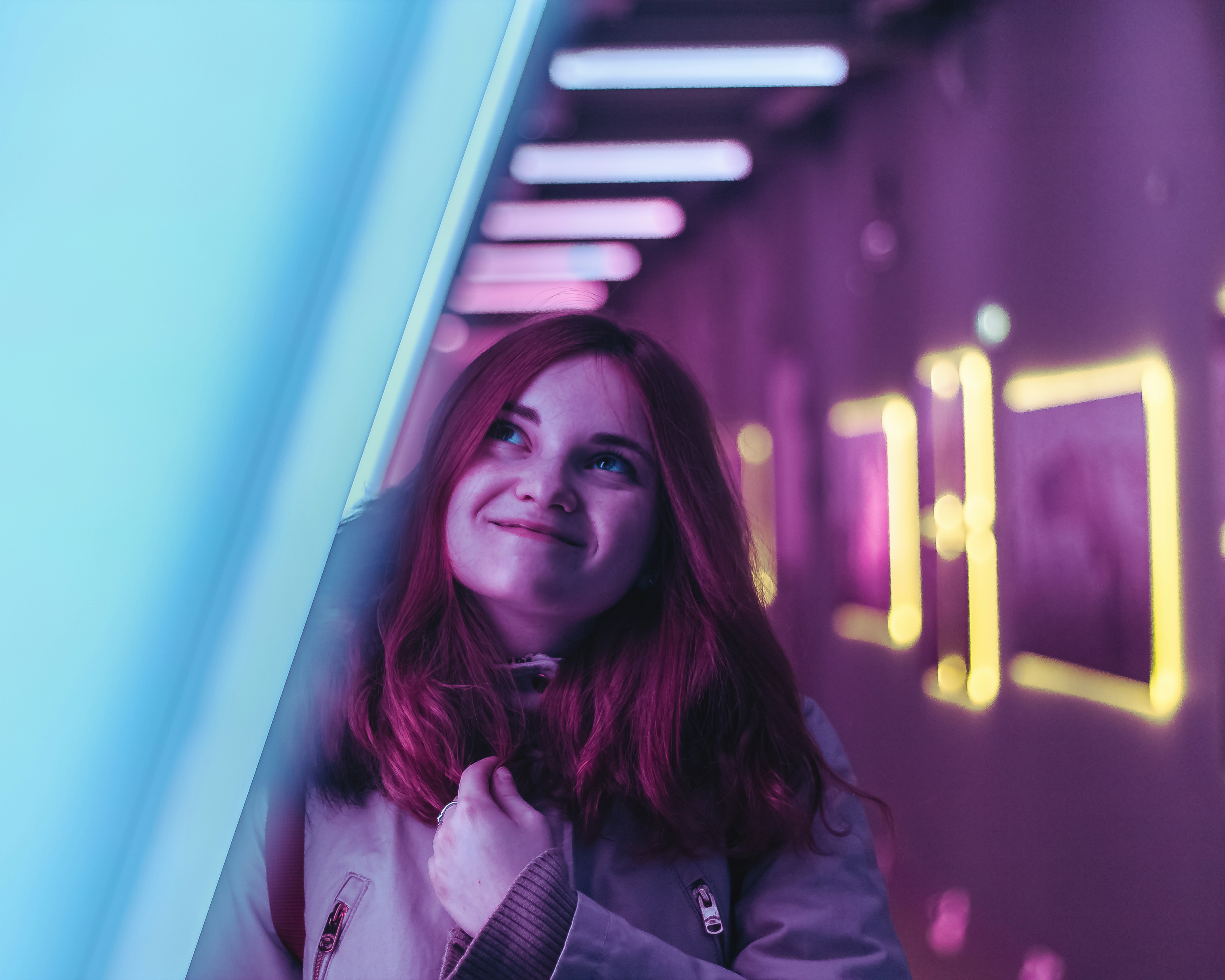 A woman standing in front of a neon sign photo – Free Portrait Image on ...