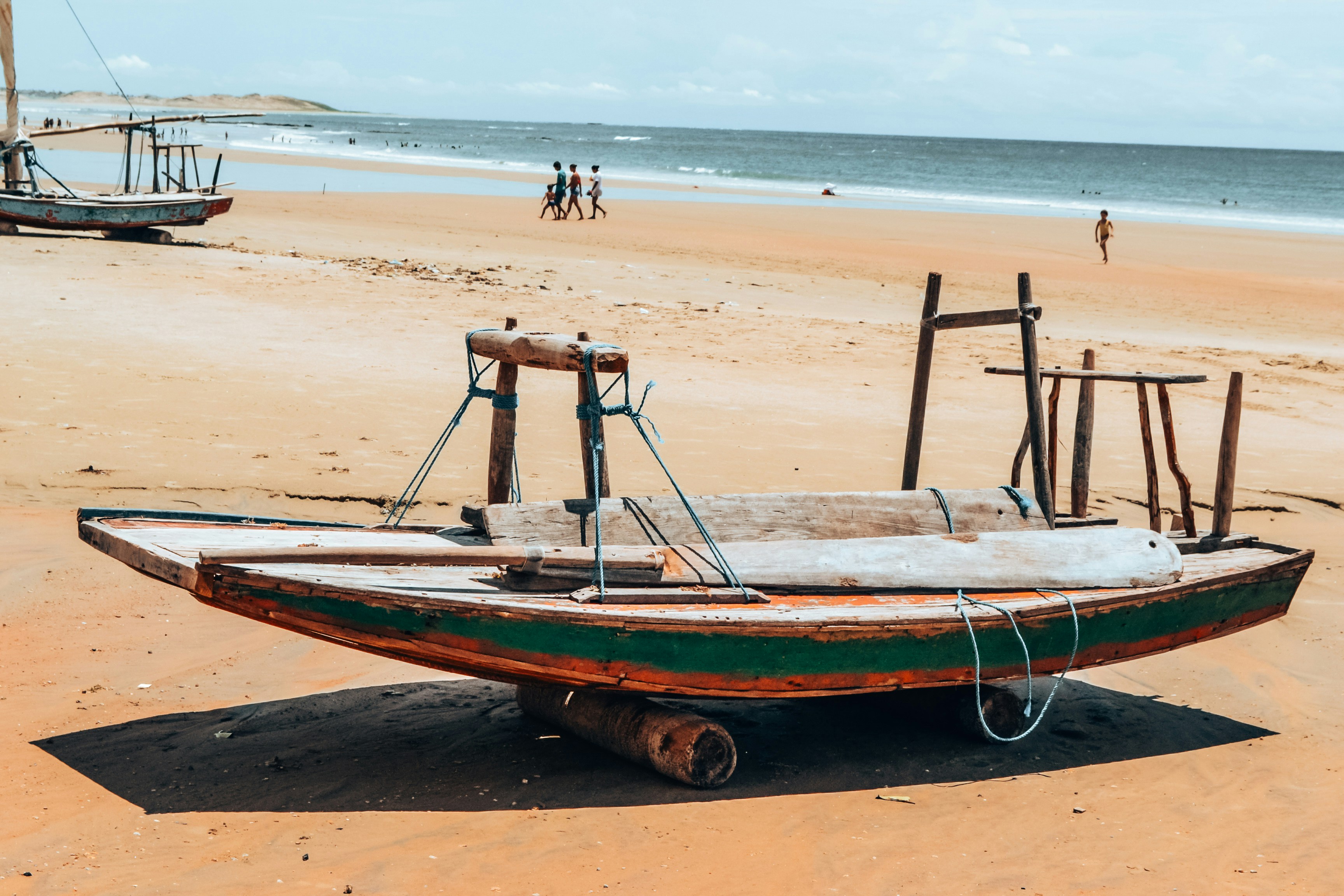 a boat sitting on top of a sandy beach