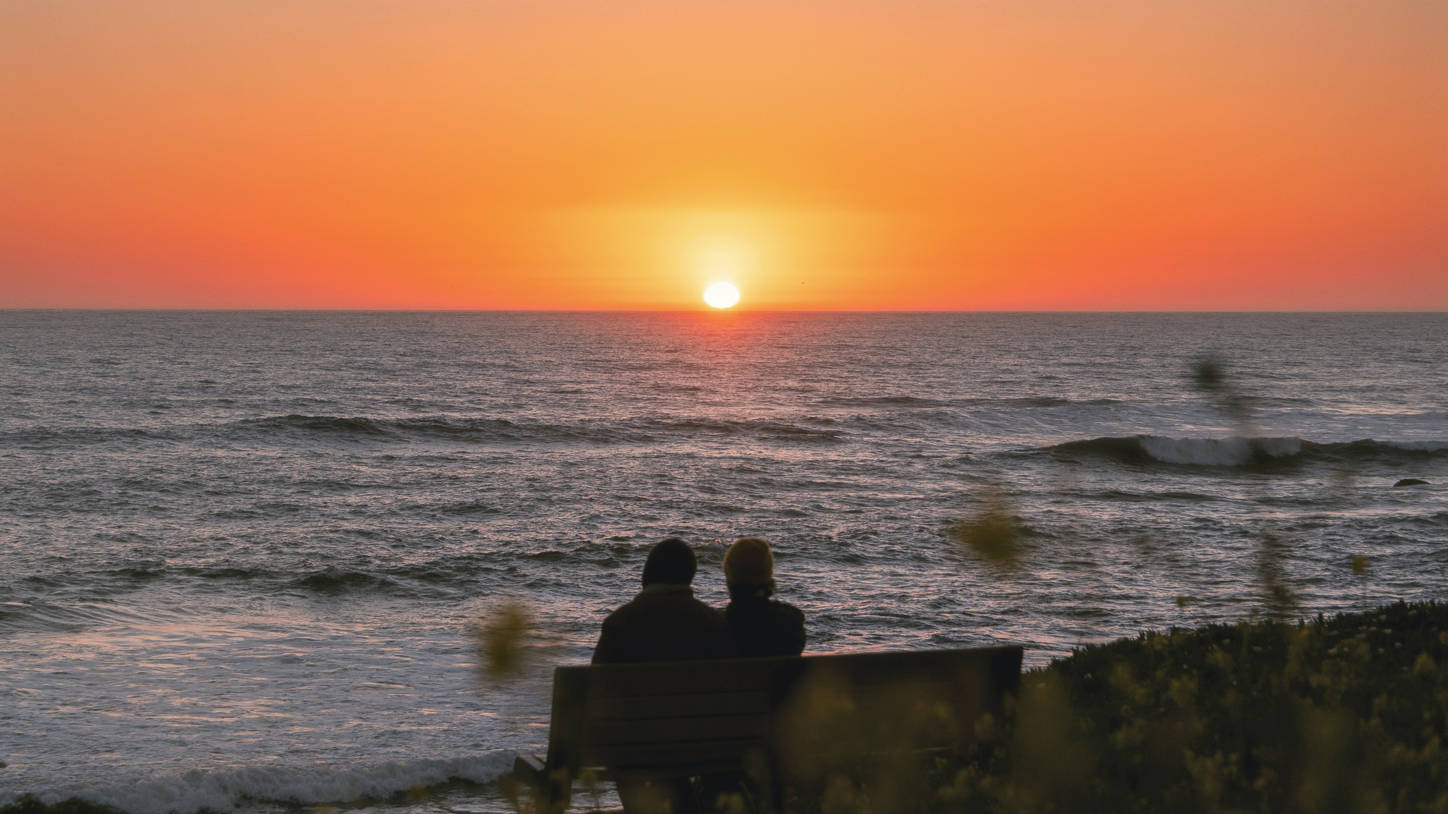 Two people sitting on a bench watching the sunset photo – Free Sky ...