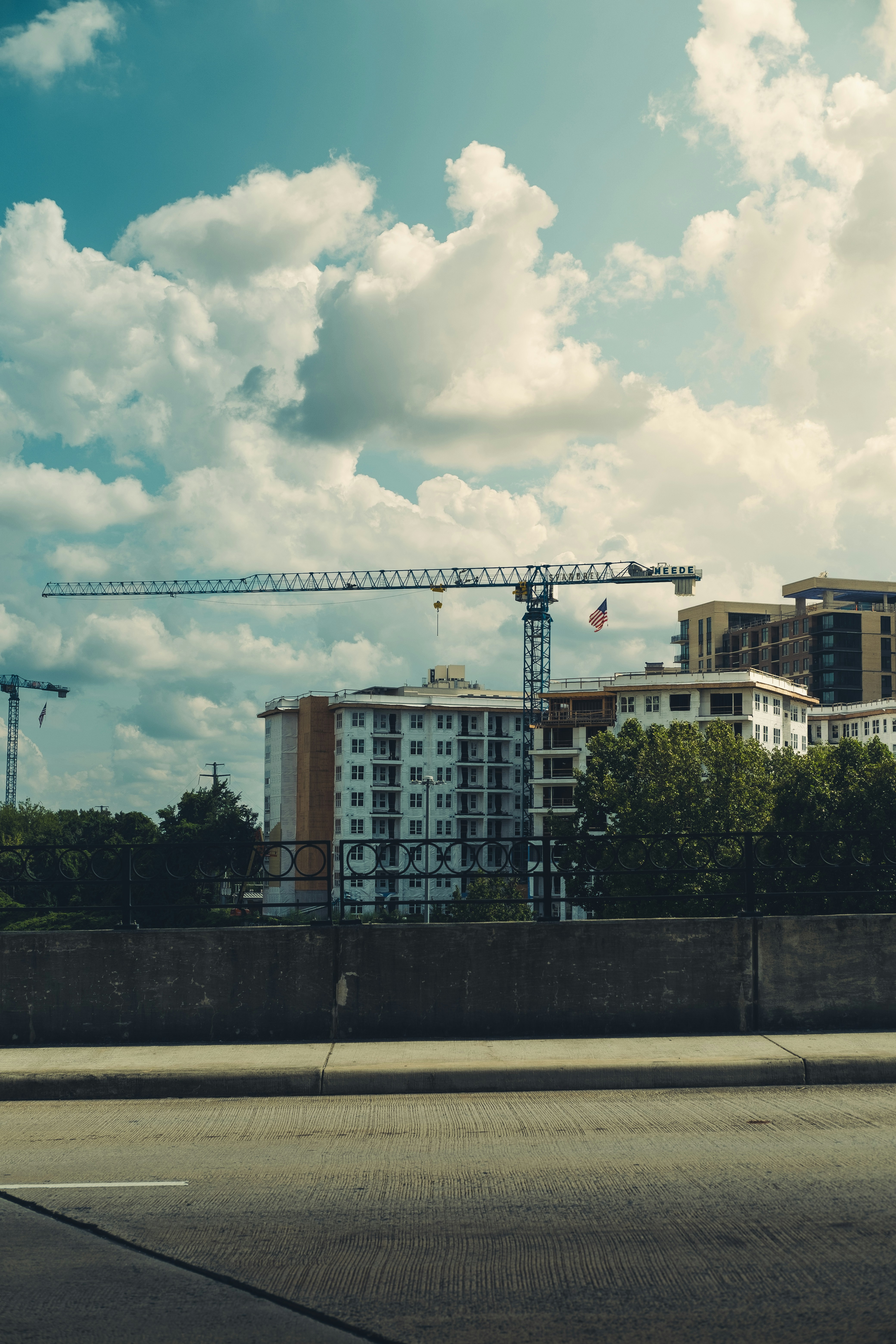 A large building under construction with a crane in the background ...