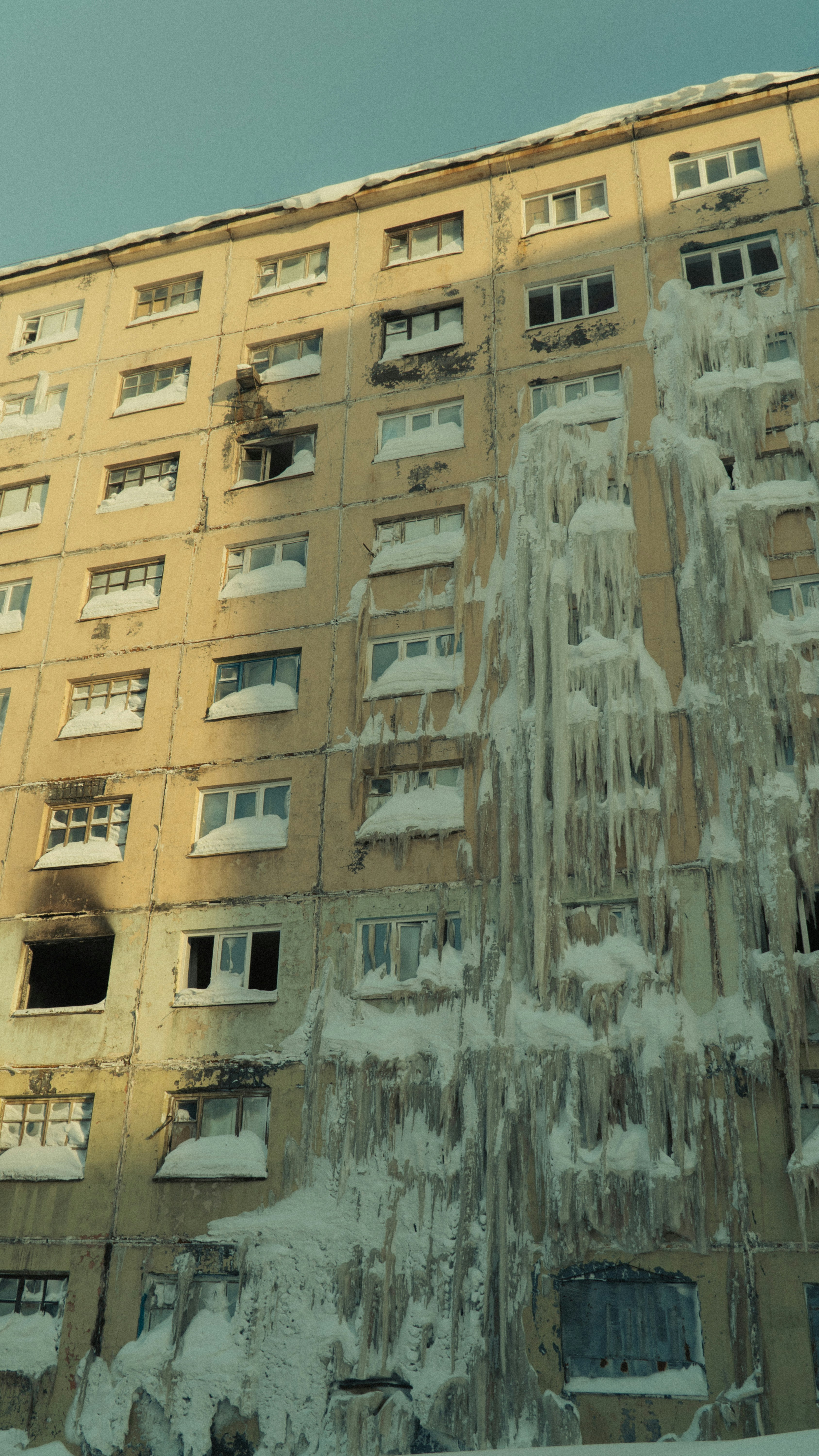 Winter Facade: Ice-Cascading Cliffs on a Soviet-era Building
