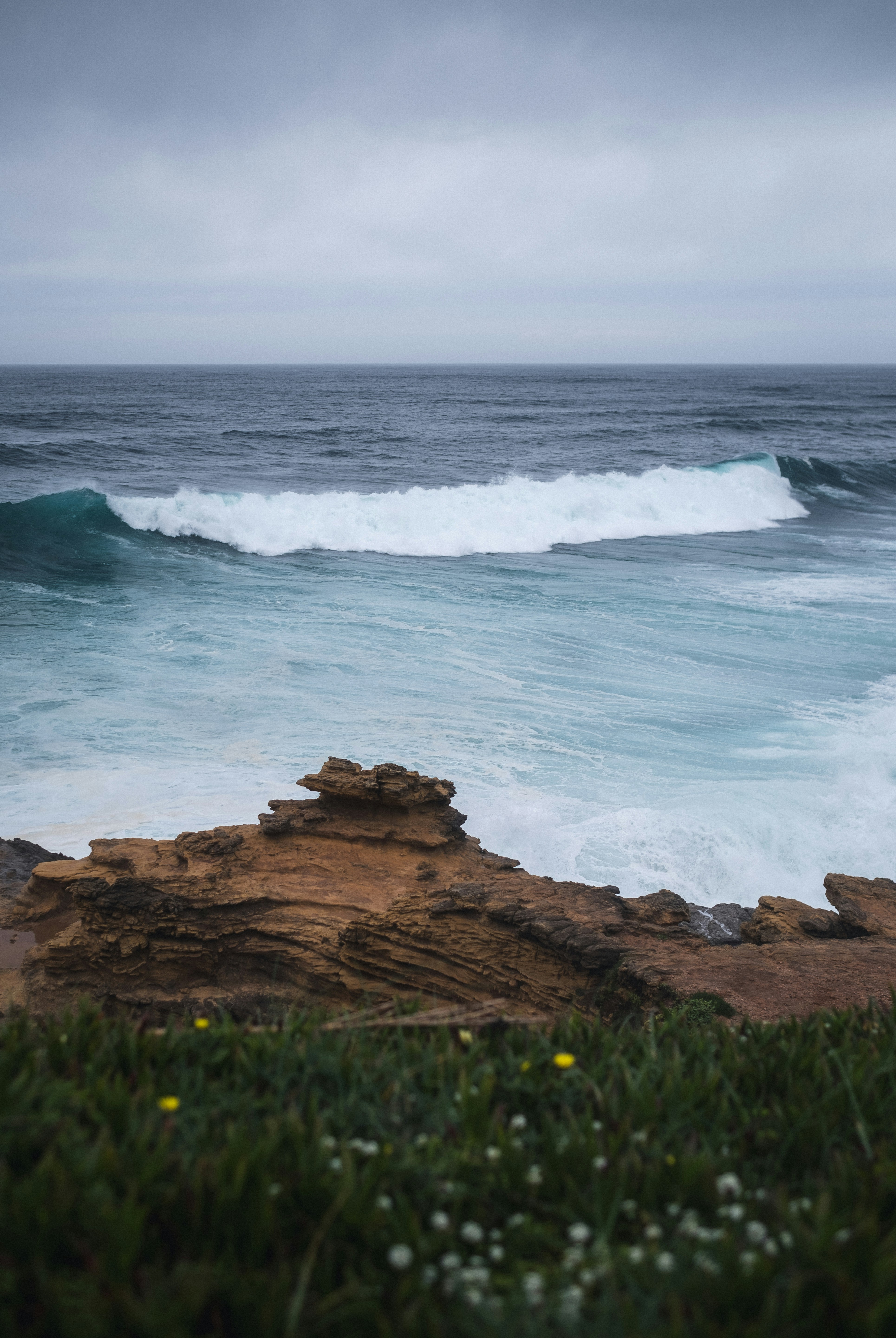 Crest and Cliff: Breakers Against Weathered Stone