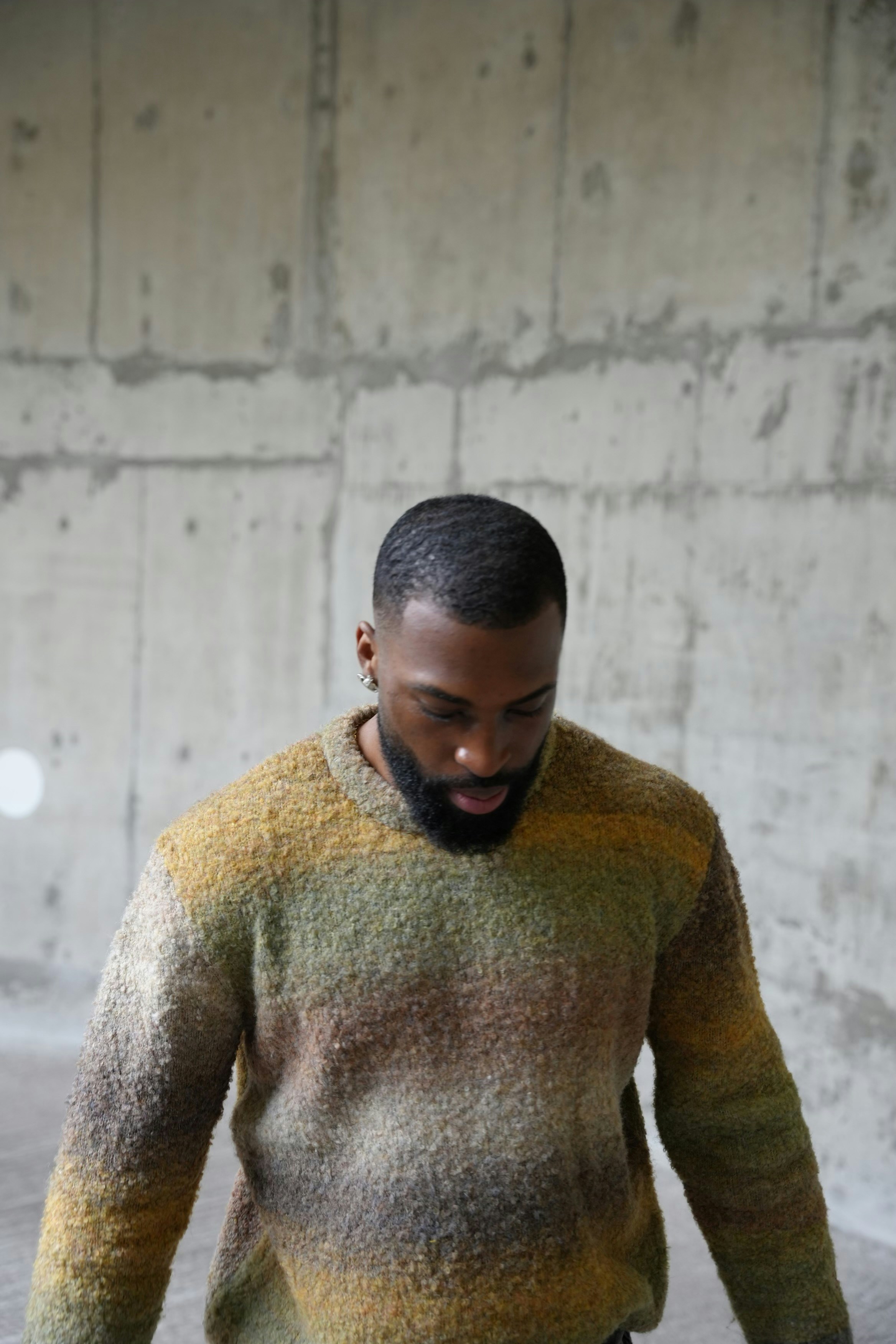Wool and Light: A Quiet Portrait in a Rough Concrete Space