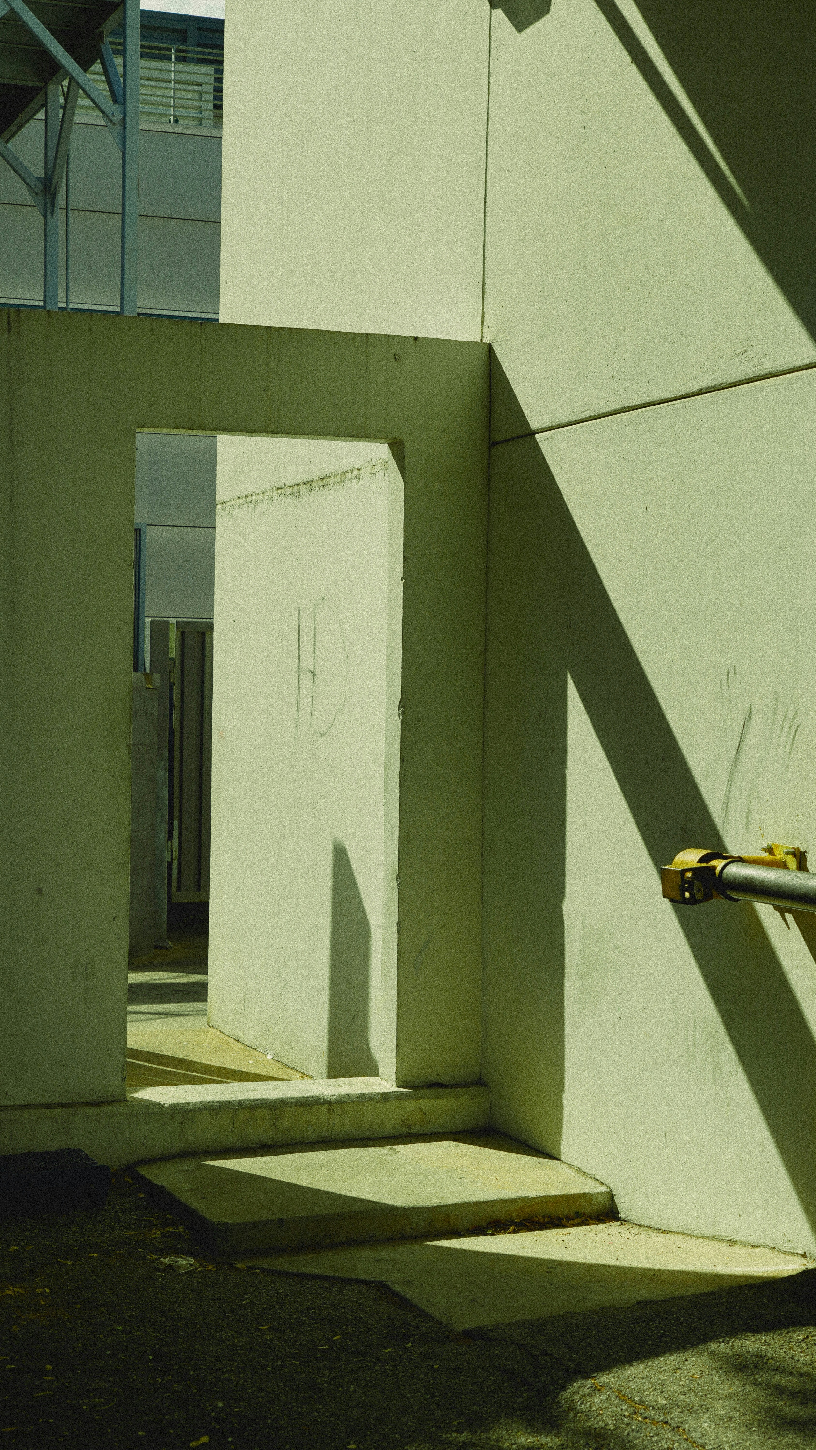 Beige Thresholds: Light and Shadow in a Concrete Corridor