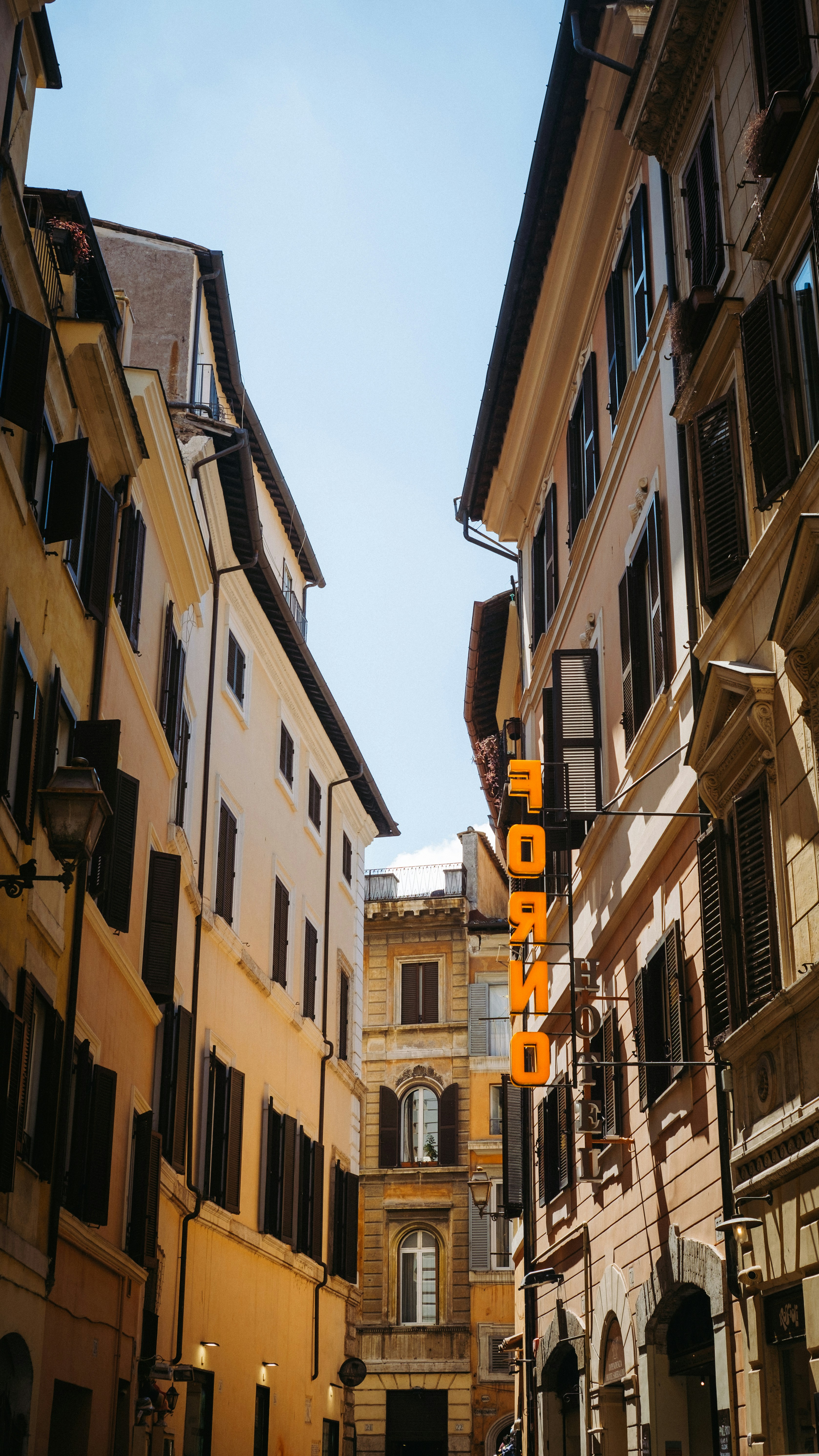 Street in central Rome | a street with buildings and a street sign