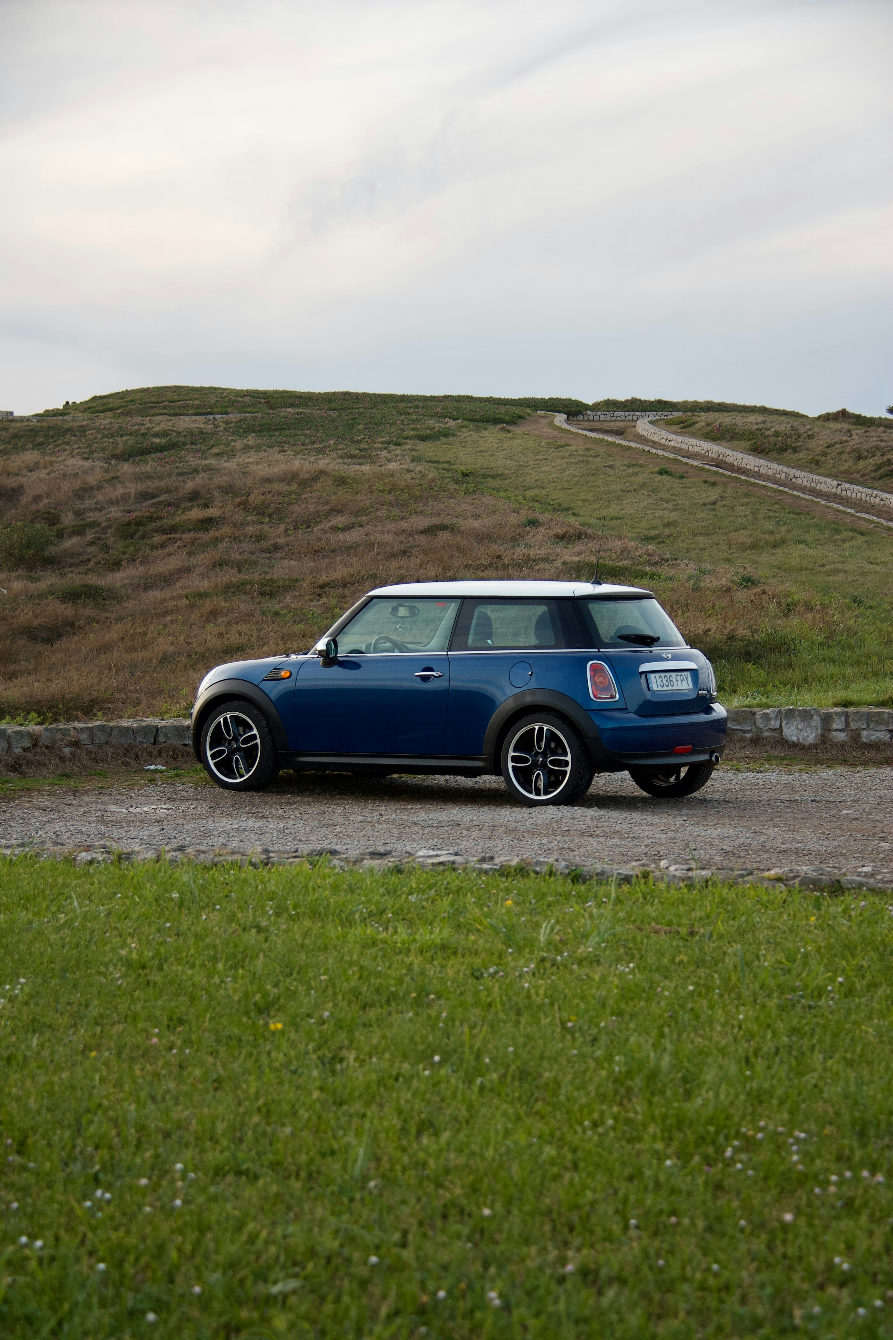 A small blue car parked on a gravel road photo – Free Vehicle Image on ...