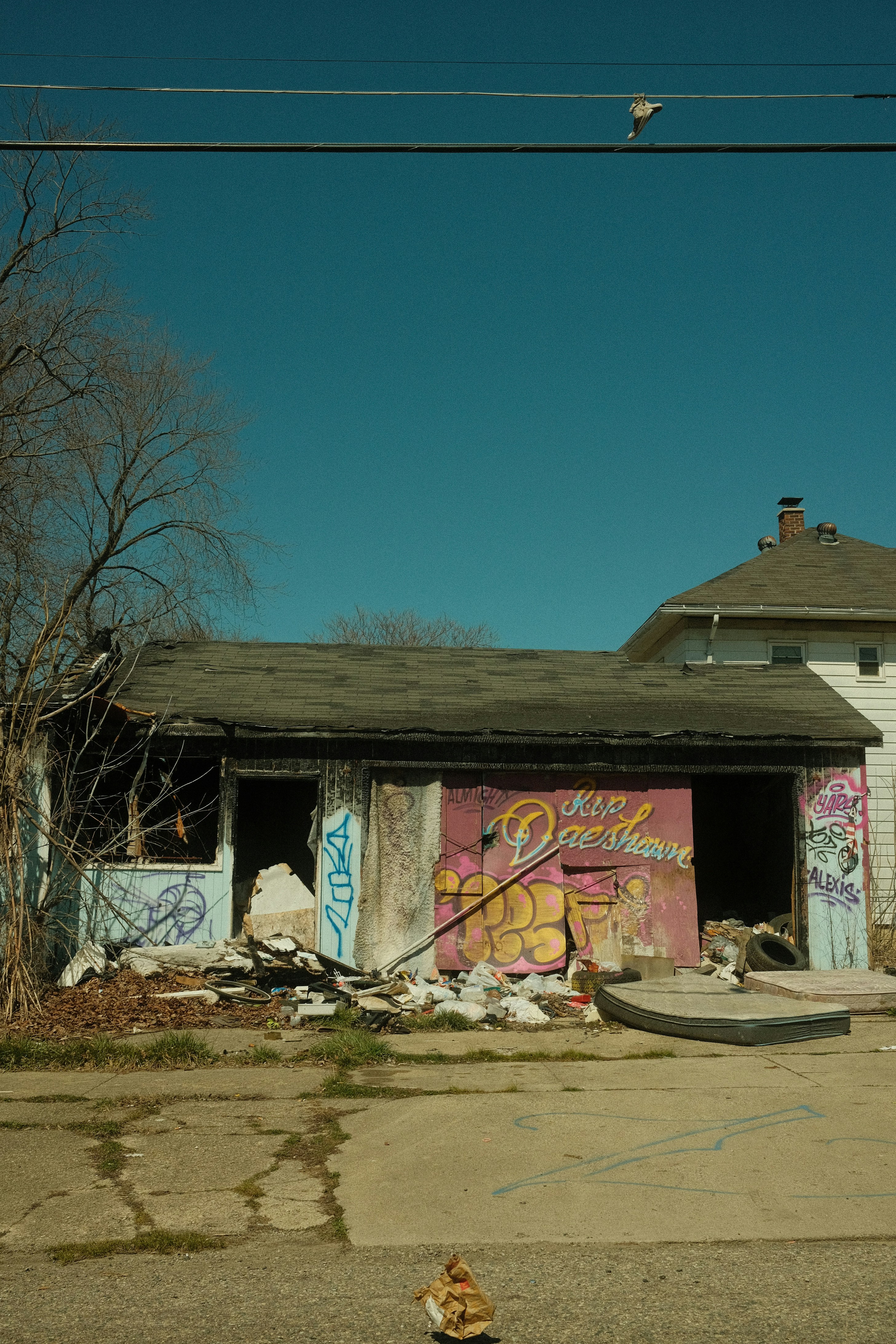 Graffiti Gatehouse: Sunlit Ruin Under a Clear Sky