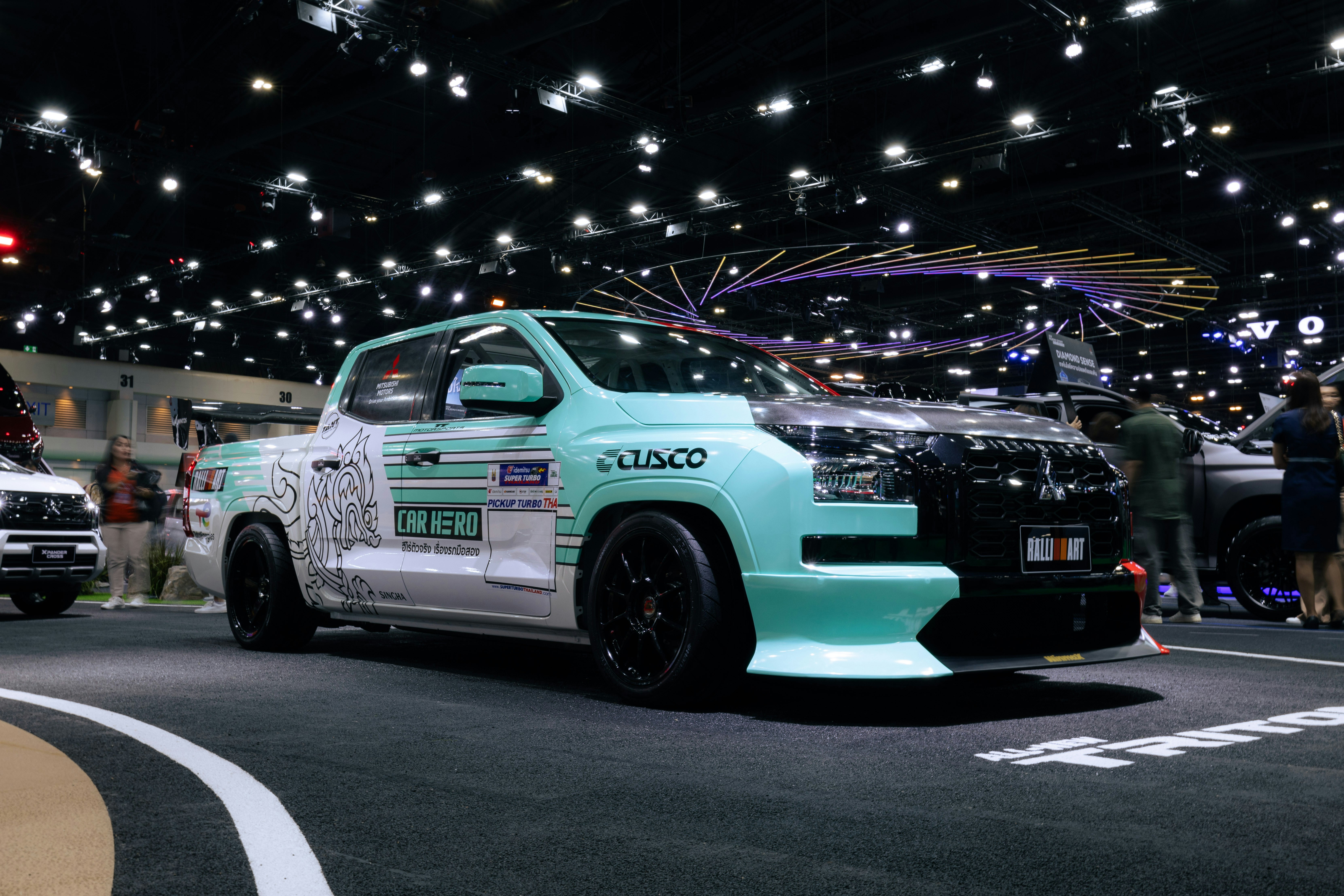 Mint-Turquoise Show Truck: A Neon-Glossed Pickup on the Arena Floor