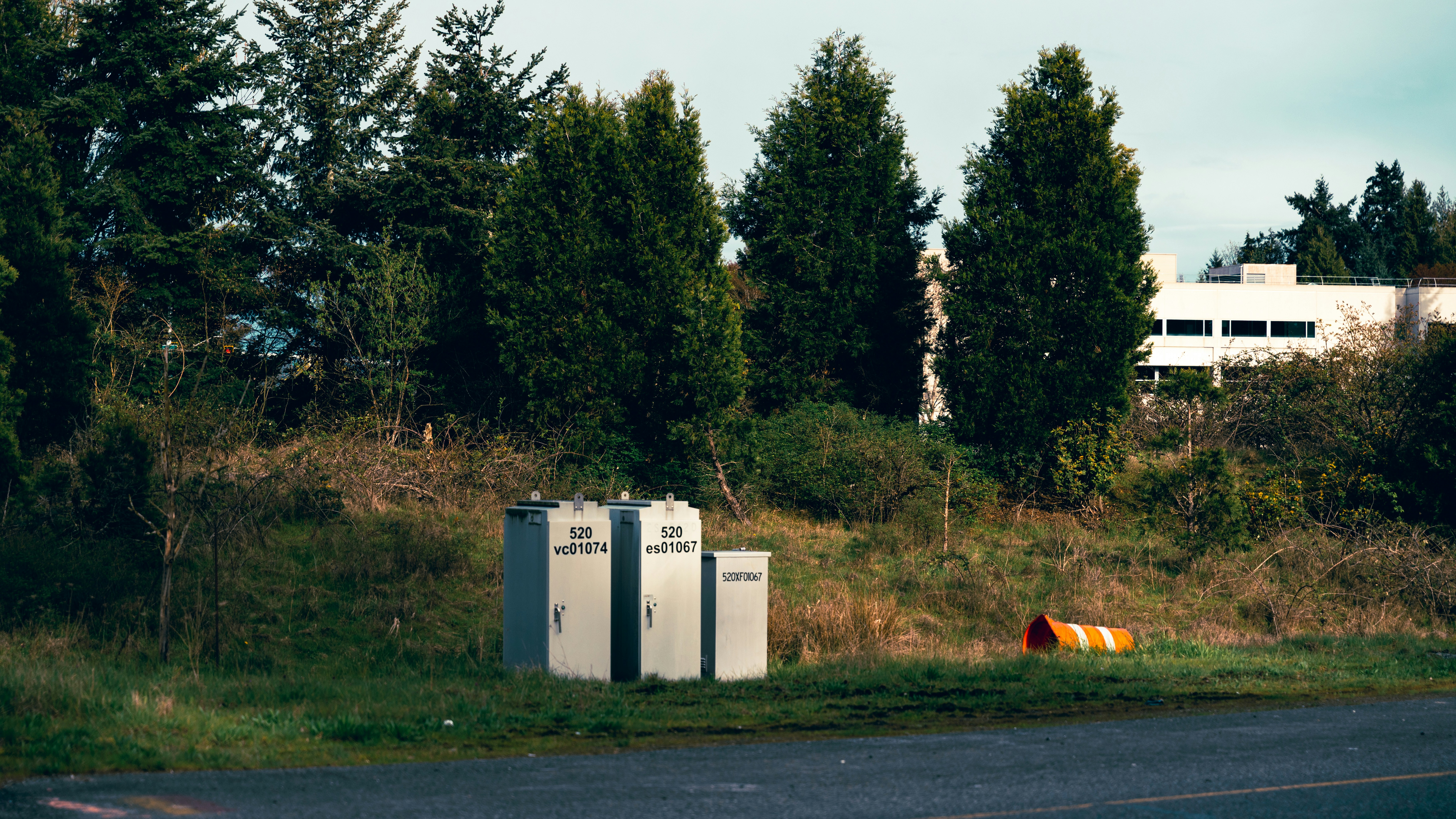 A couple of boxes sitting on the side of a road photo – Free Highway ...