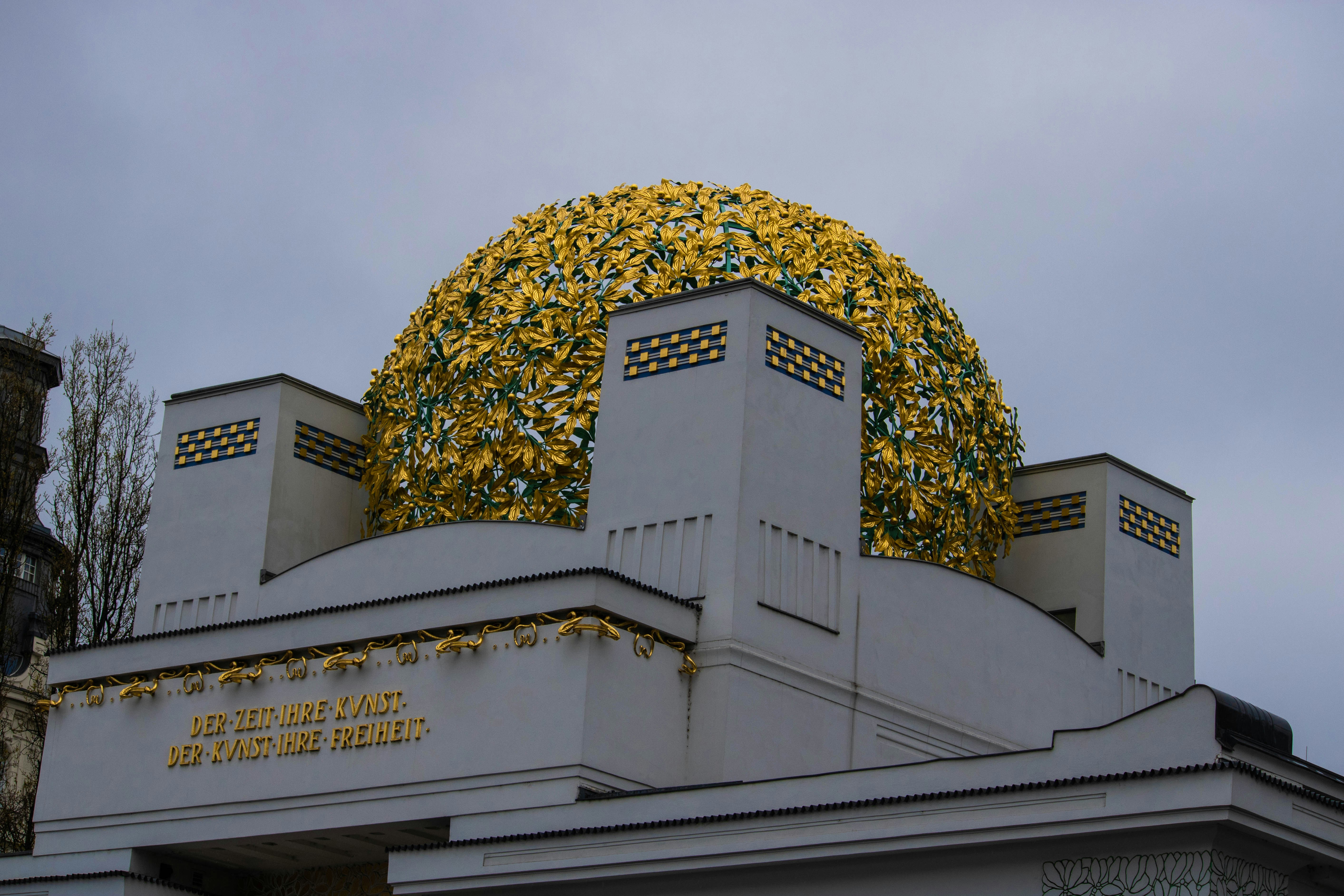 Gilded Sphere Crowns a Neoclassical Roofline