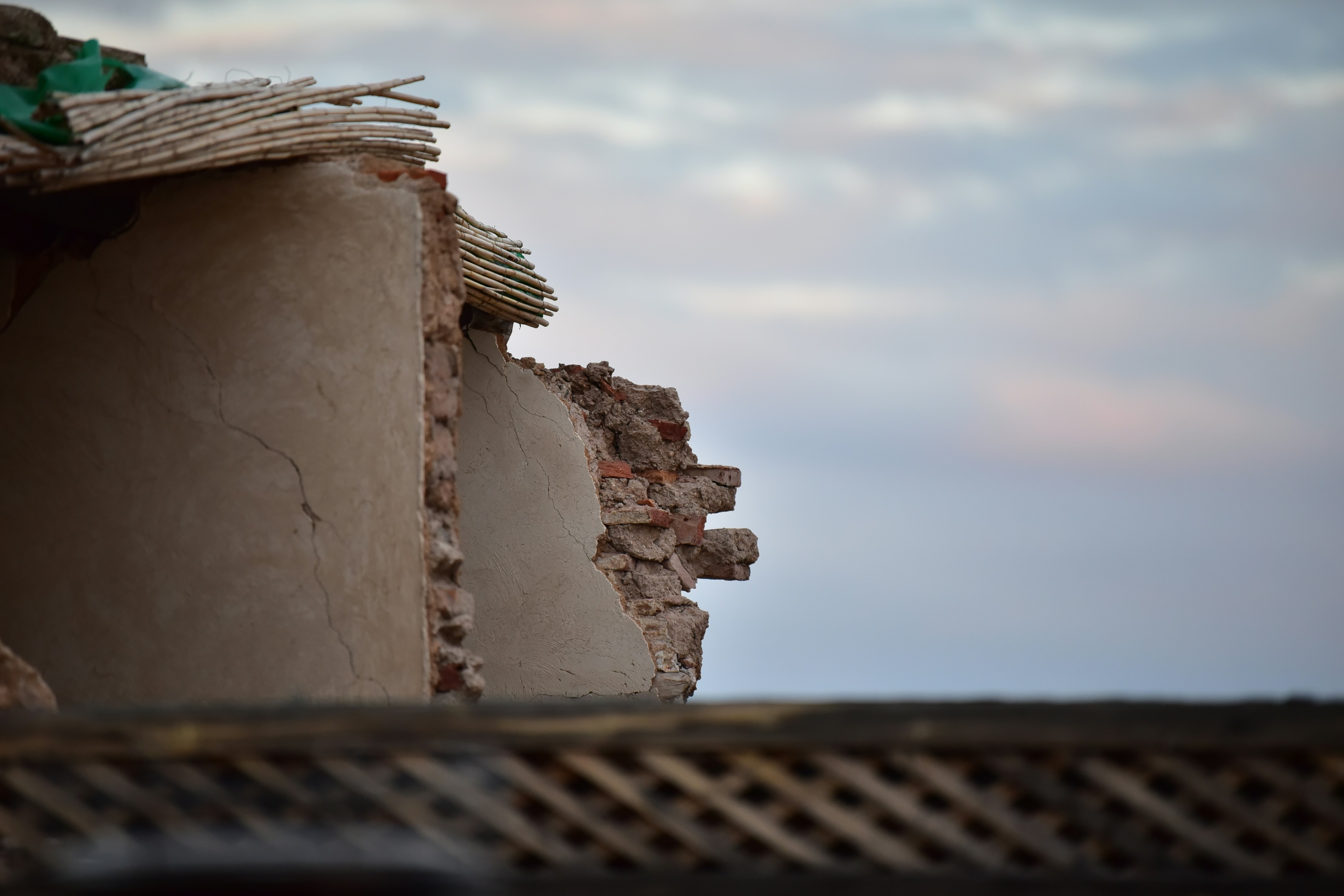 Ruin's Edge: Brickwork Fractures Under a Dusk-Tinted Sky