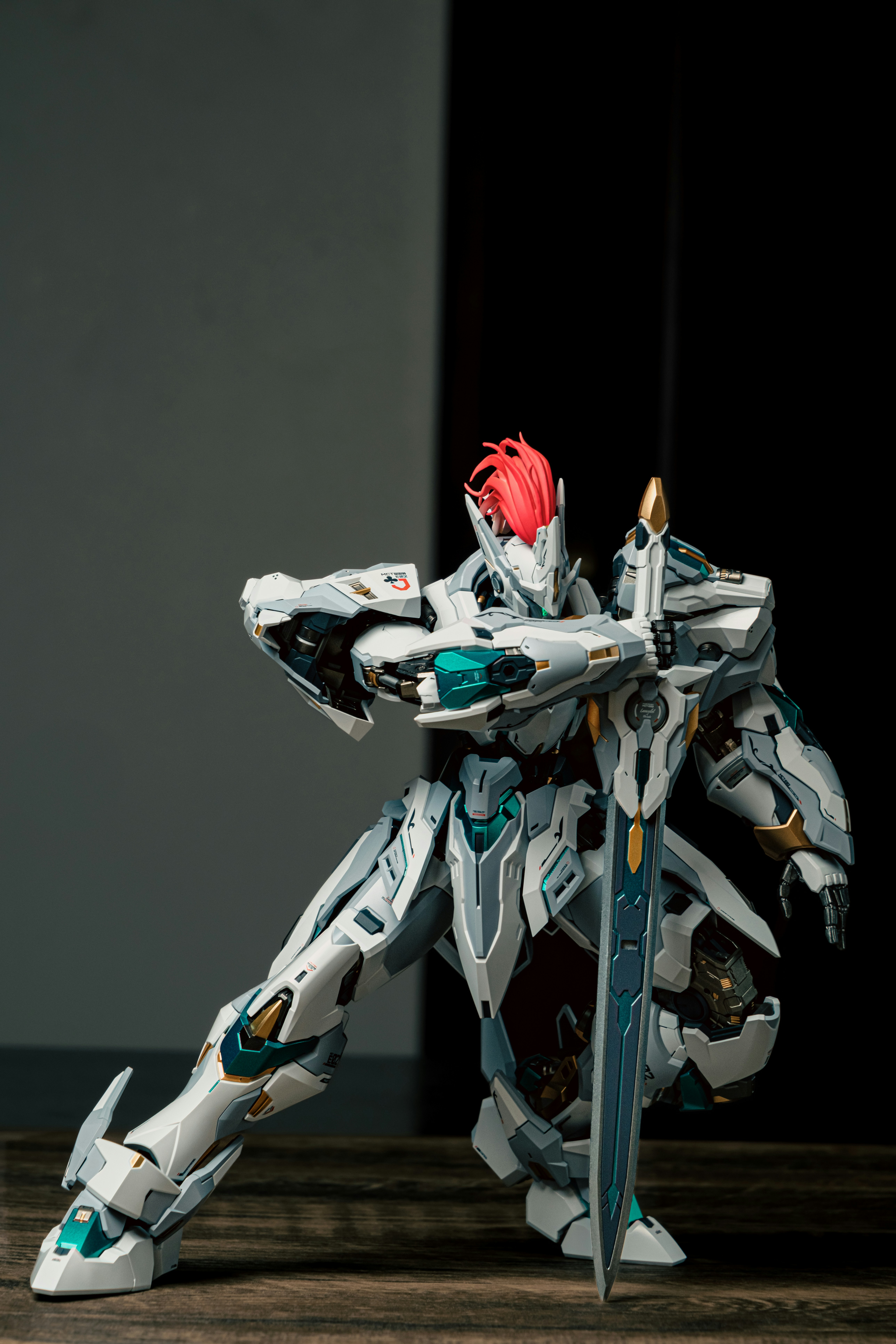 A white and blue robot with a sword on a table photo – Free Gundam ...