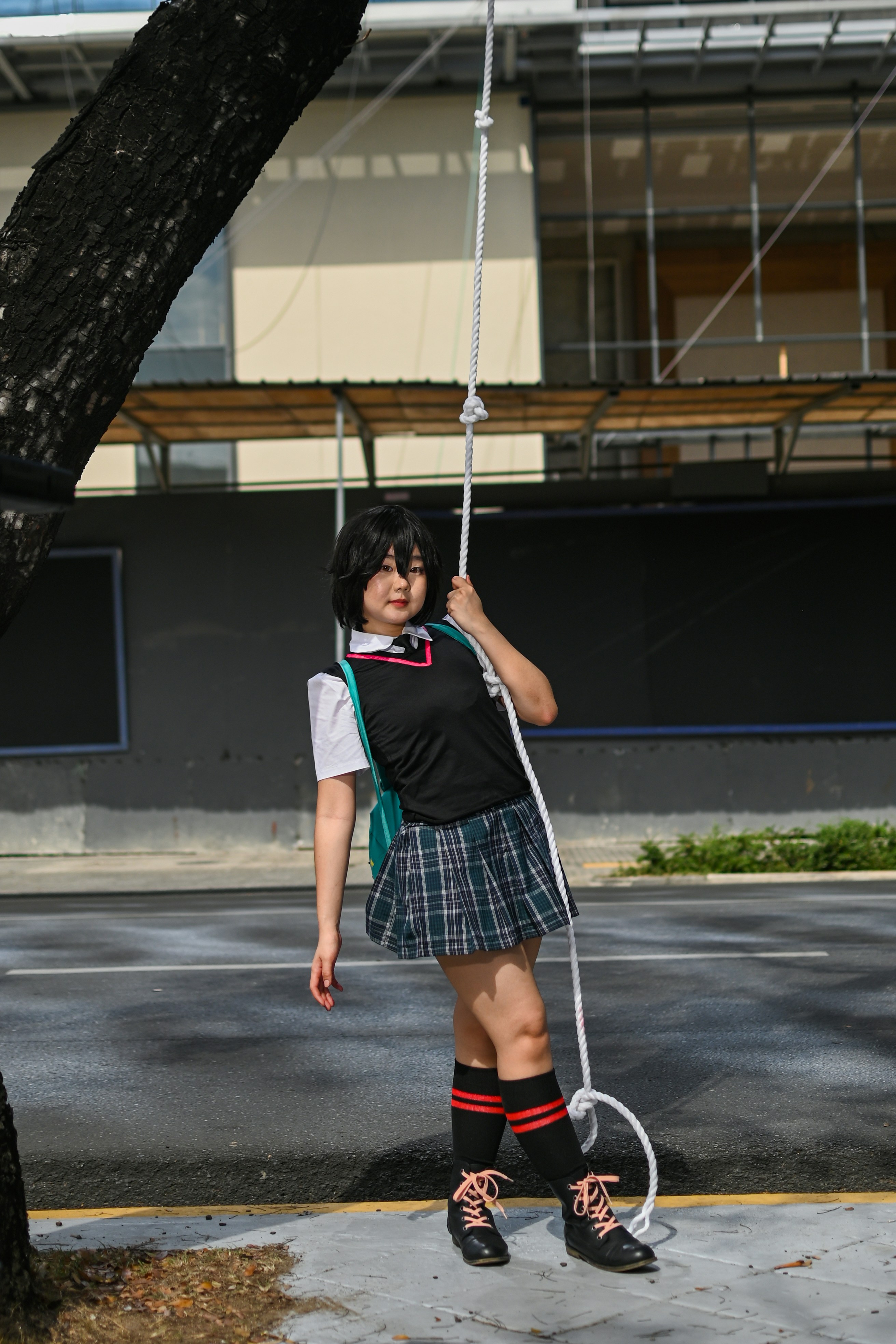 Rope on the Edge: A Schoolgirl Pauses by the Urban Wall