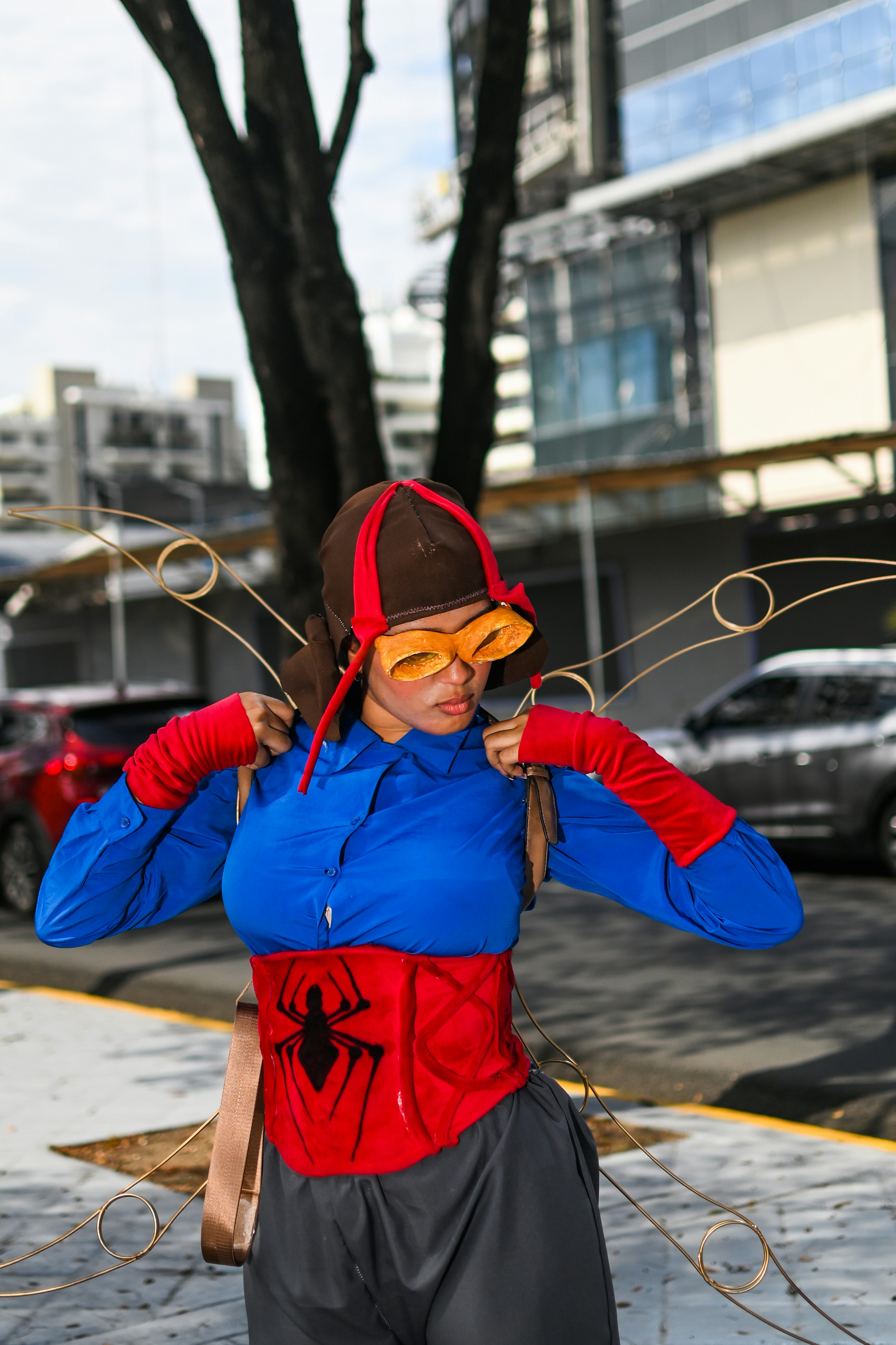 Urban Web Weaver: Colorful Spider-Costume Pose under Sunlit City Sky