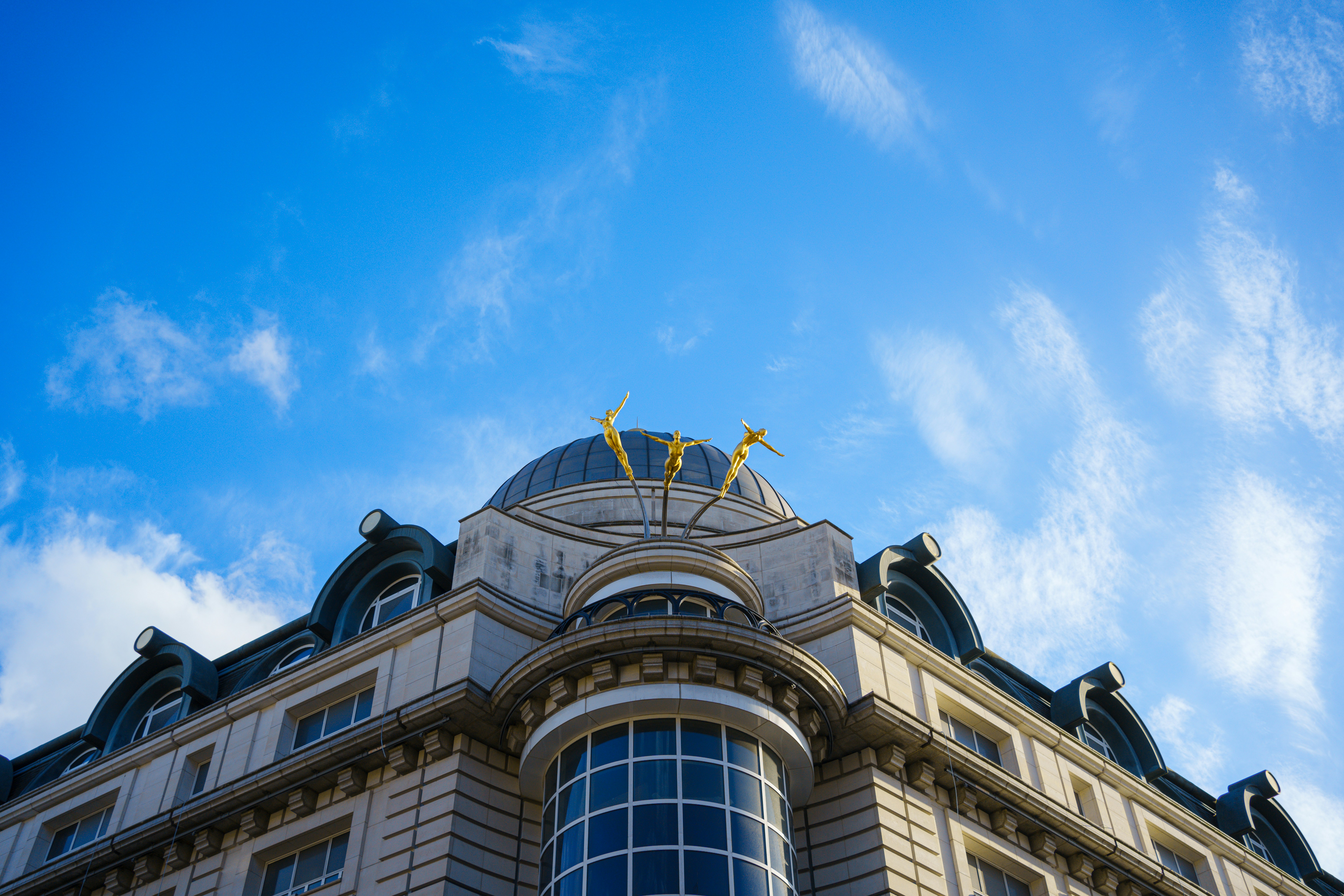 Gold Finial Crown on Beaux-Arts Facade Reaching into the Cerulean Sky