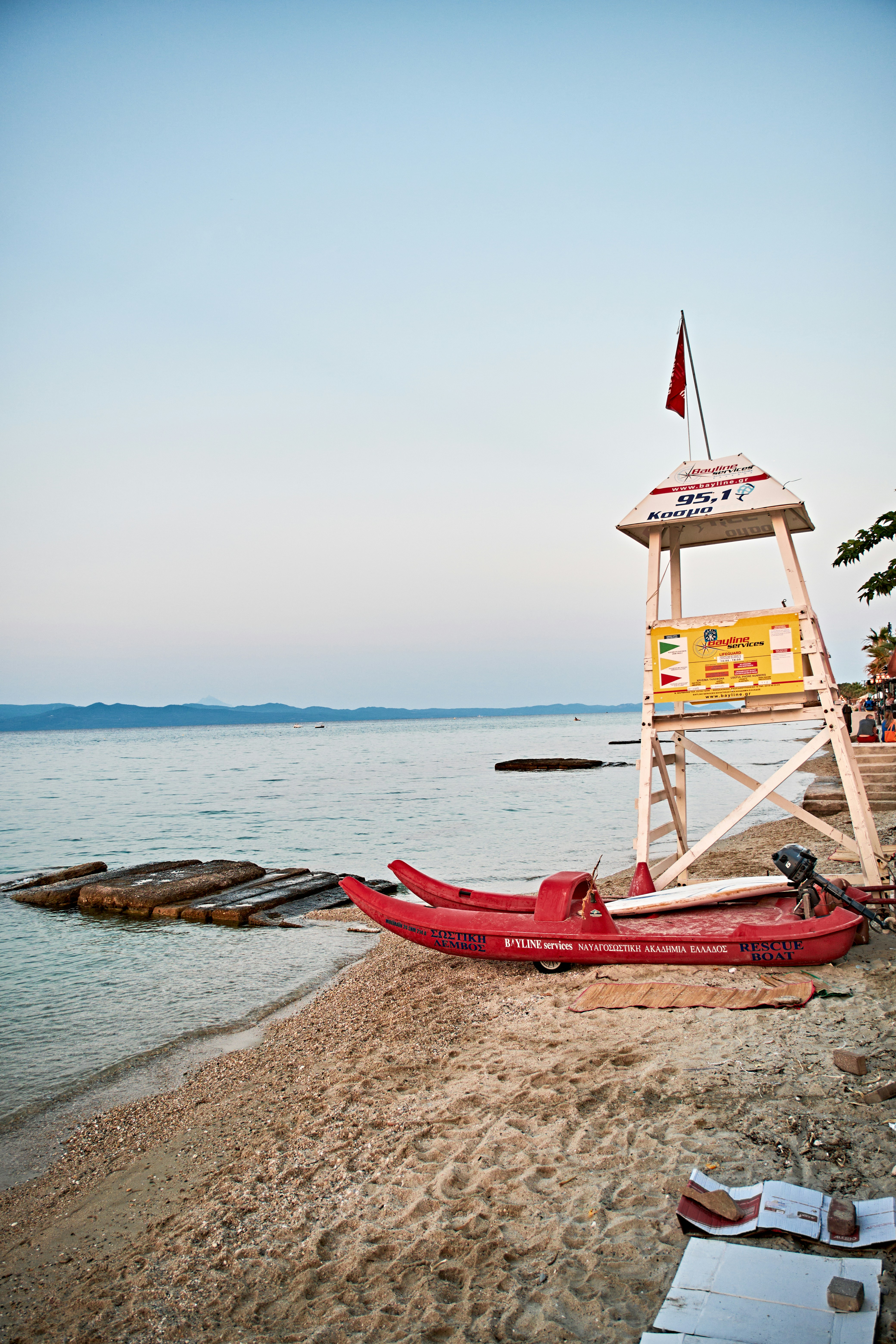 Lifeguard Tower at the Edge: Red Kayak, Quiet Sea