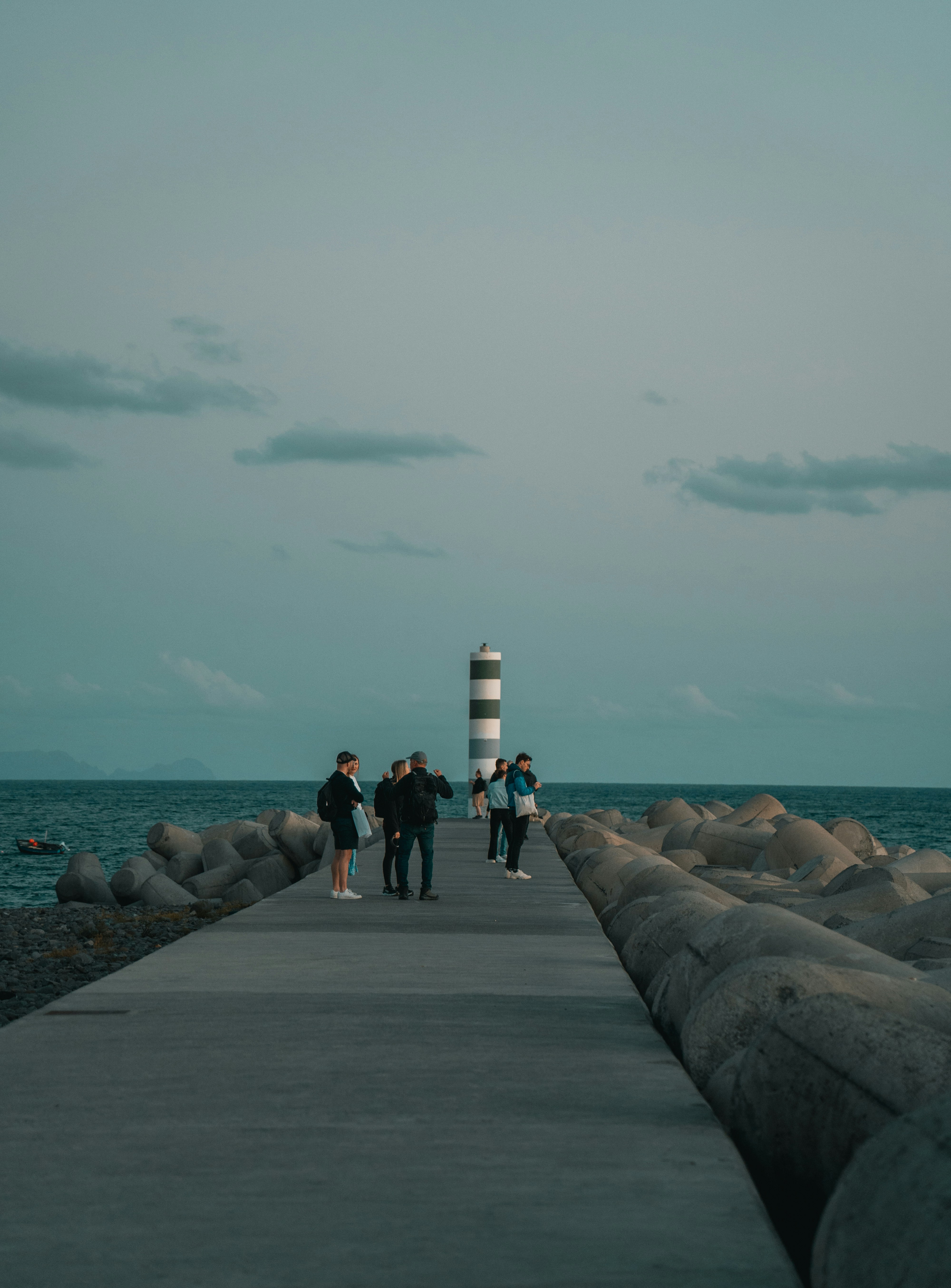 Teal Horizon Stroll: Pier Convergence on a Striped Beacon