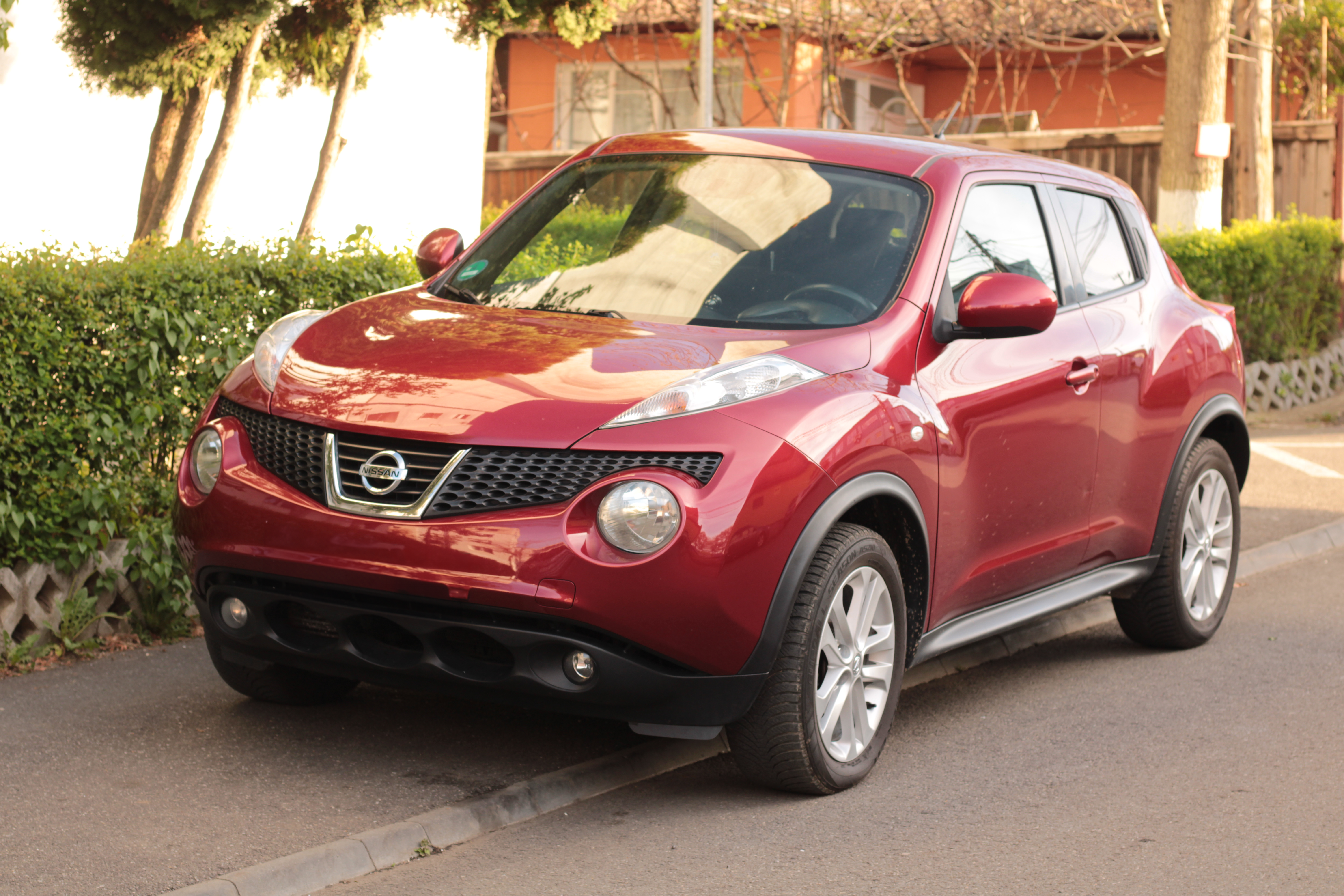 A red car parked on the side of the road photo – Free Red nissan Image ...