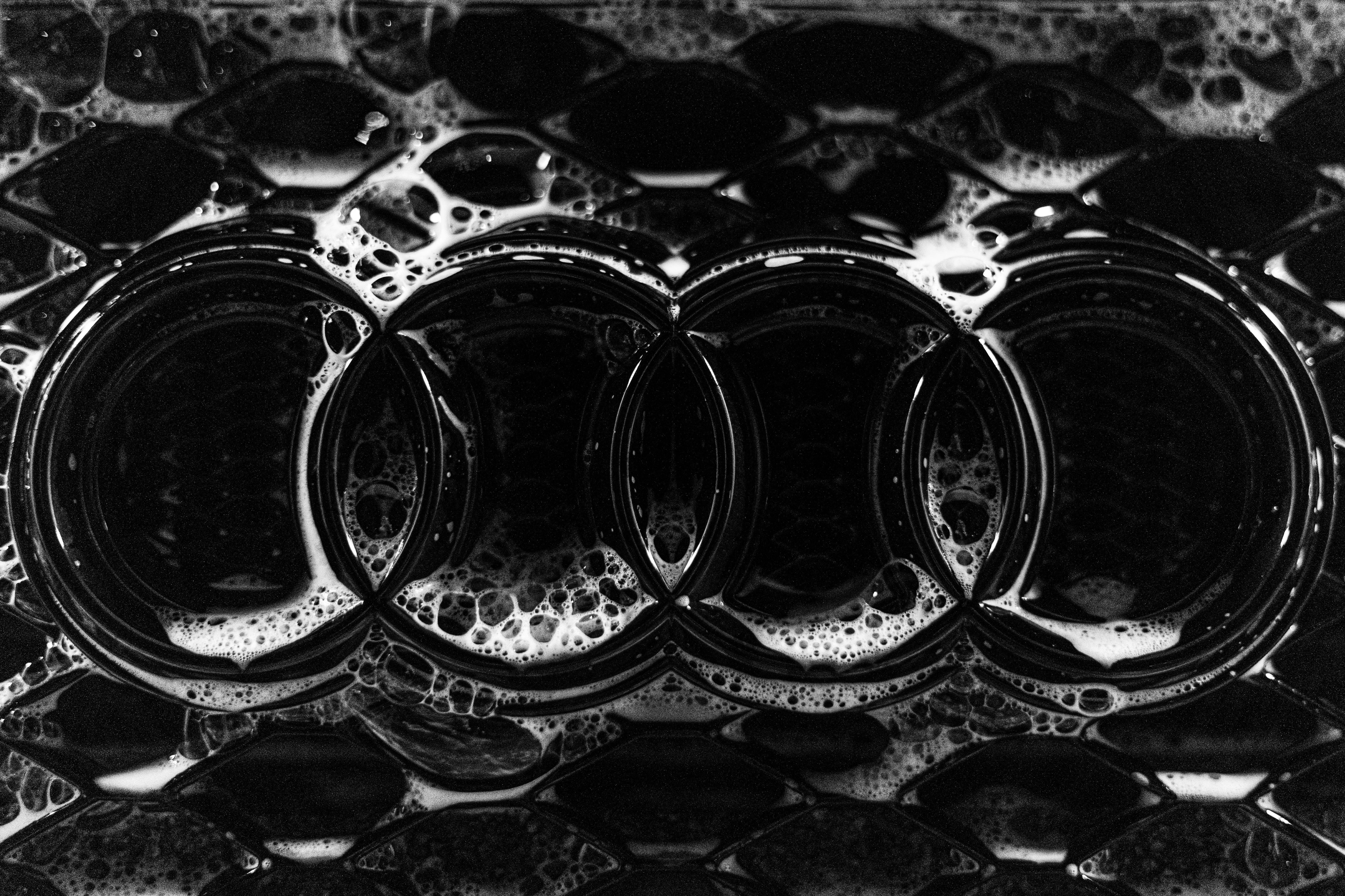 Bubbled symmetry: a row of glassy spheres under a frothy veil