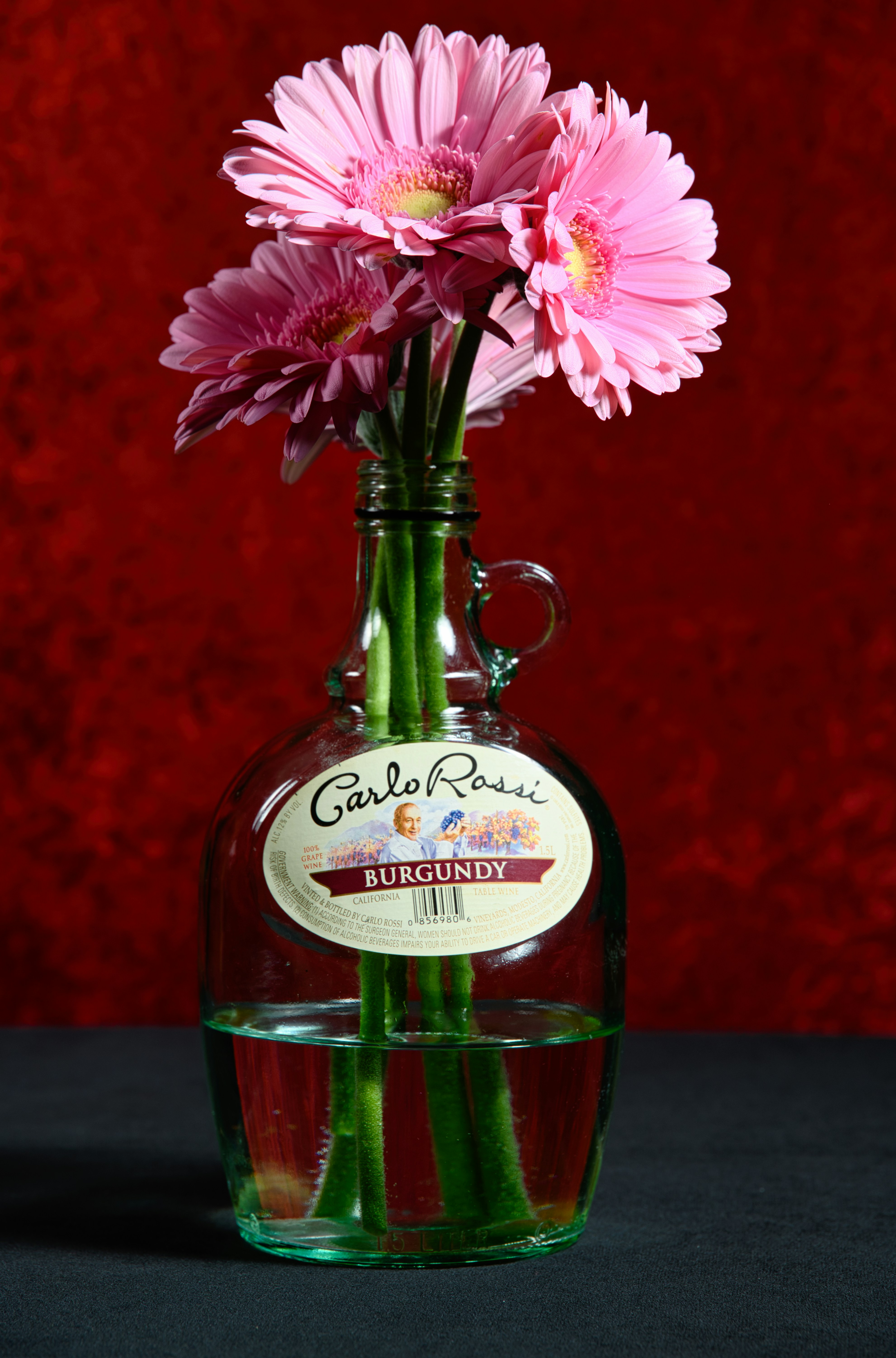 Pink Gerberas in a Burgundy Bottle: A Quiet Still-Life