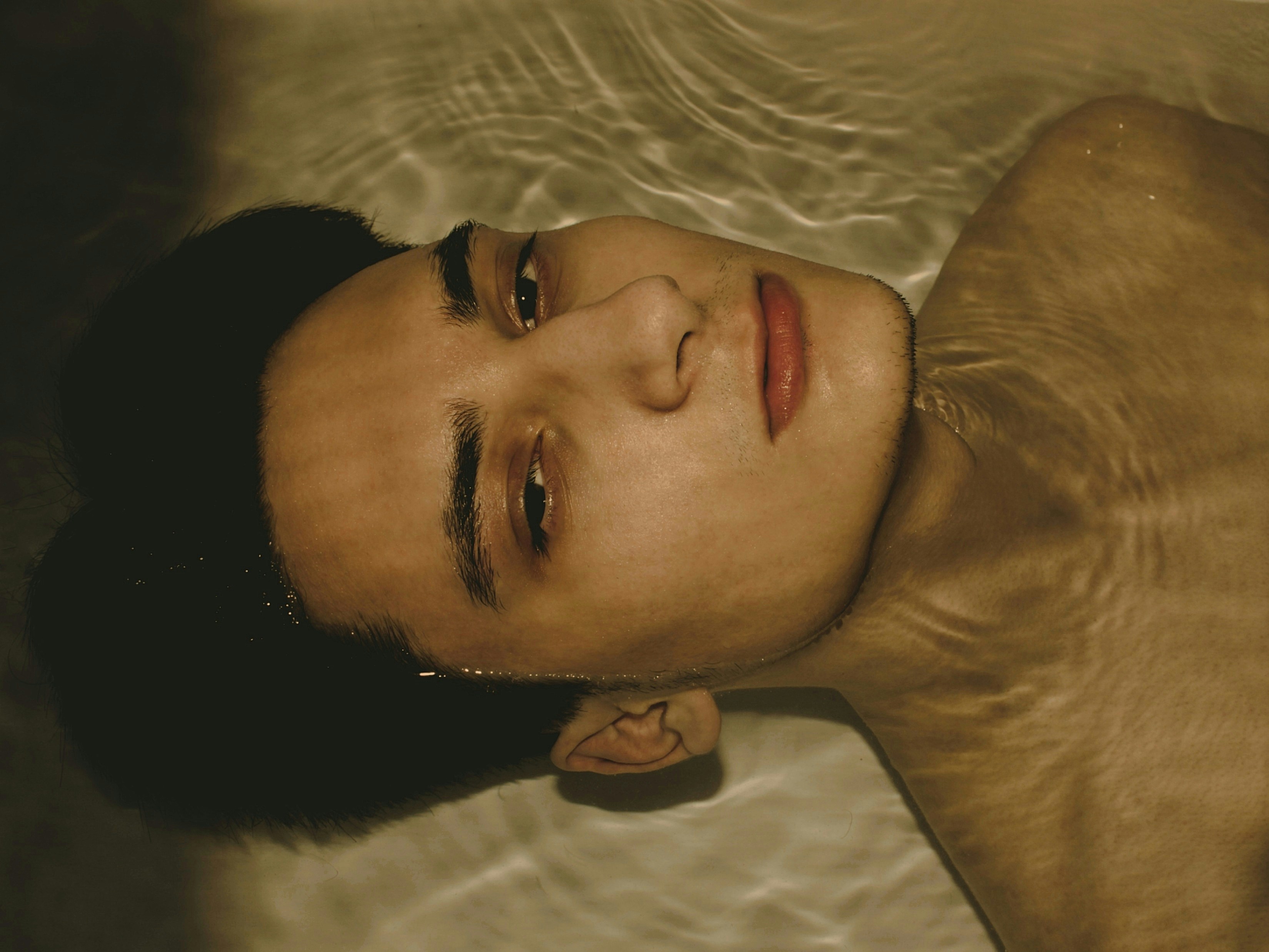 Sunken Gaze: Portrait of Quiet Confidence in Warm Water Tones