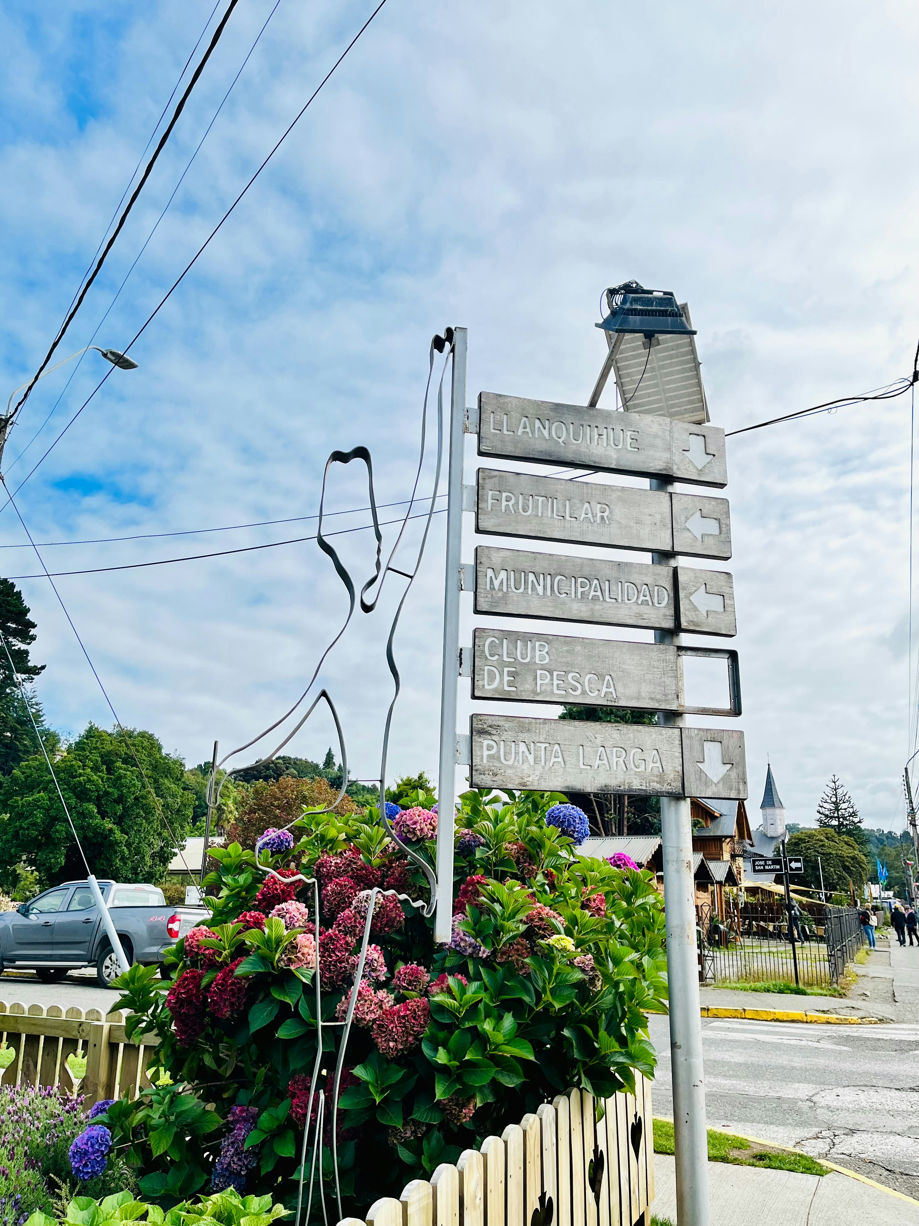Signpost Trio at a Coastal Town Square
