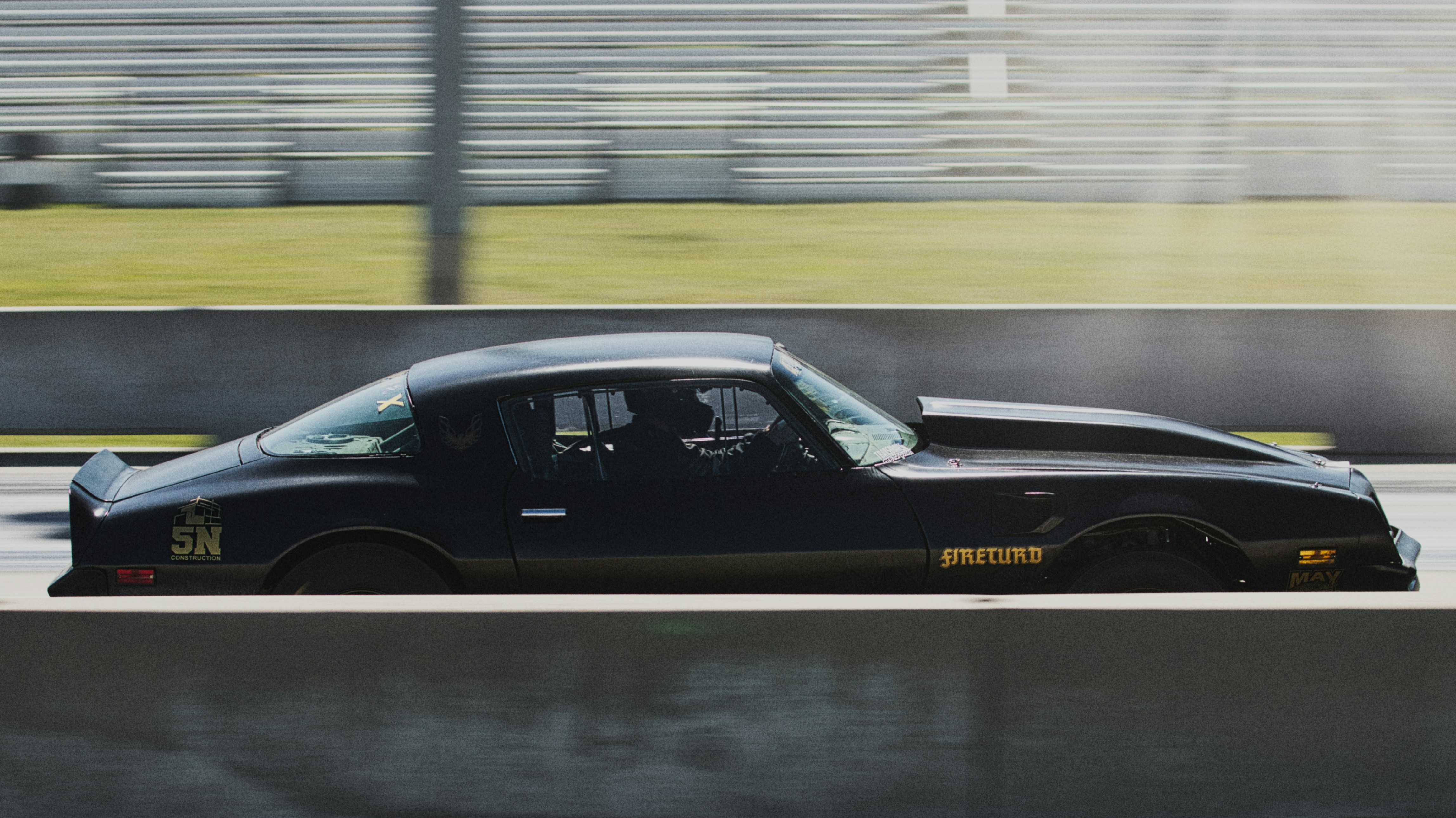 A black car driving down a race track photo – Free Ardmore dragway llc ...