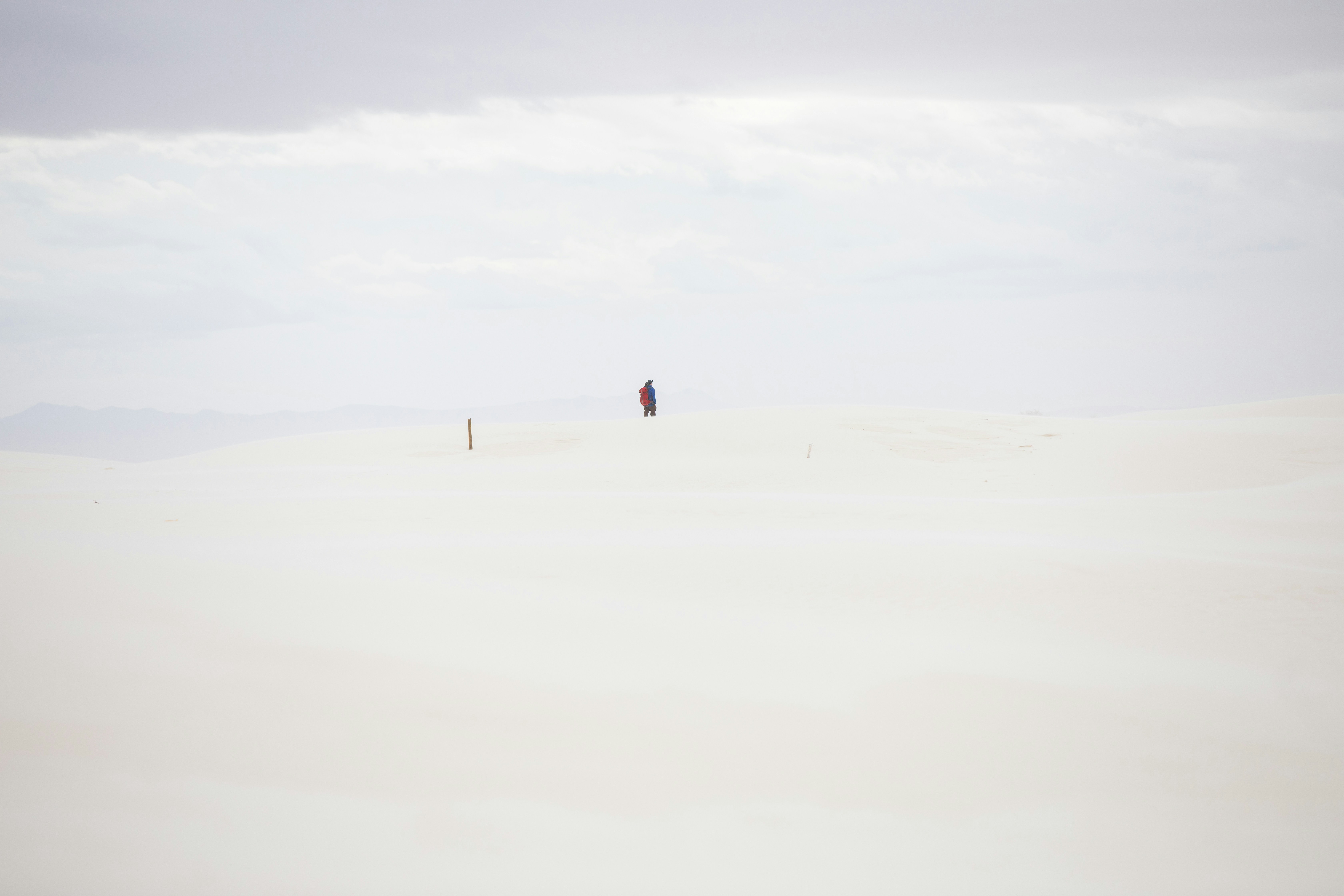 A couple of people walking across a sandy field photo – Free Nature ...