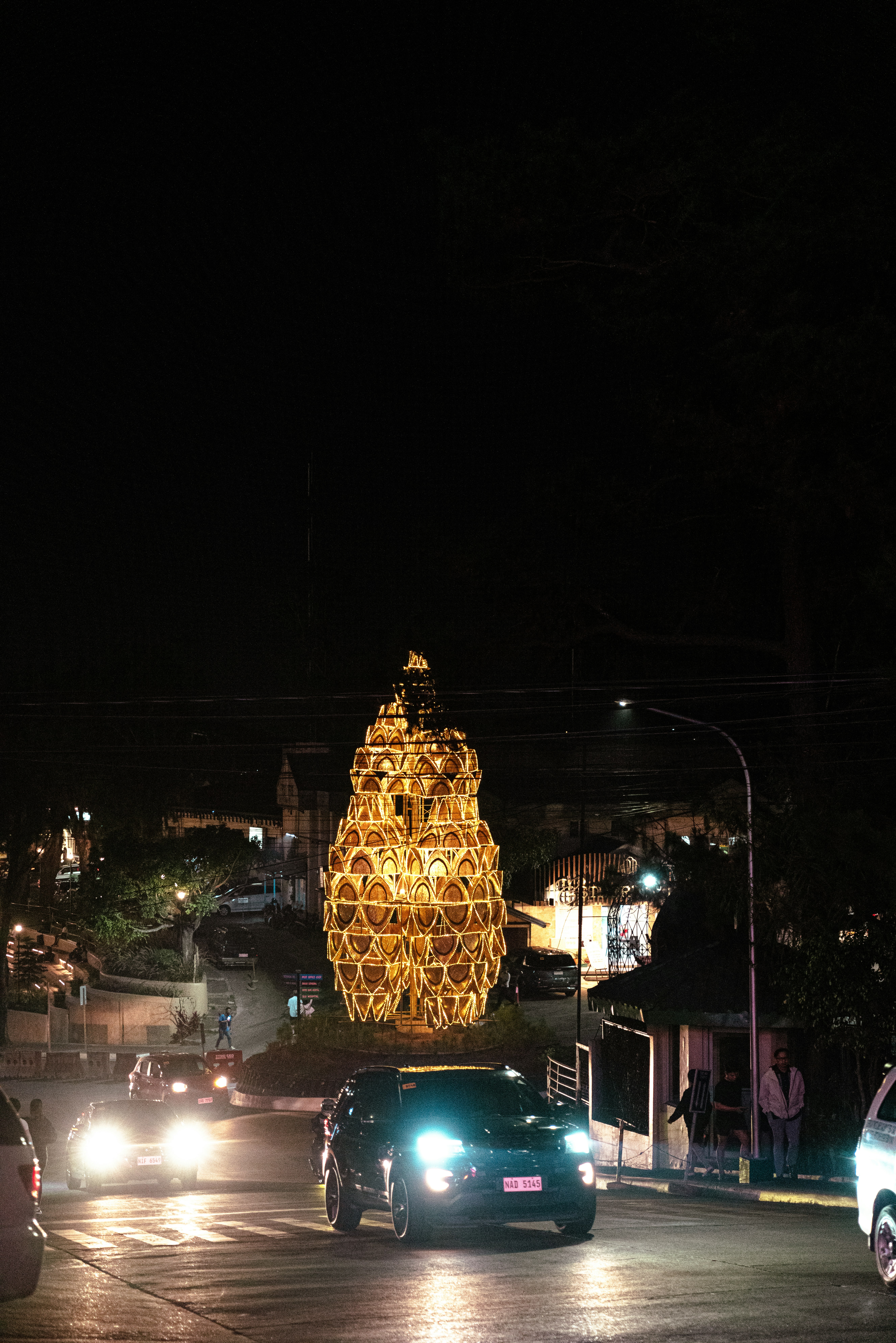 Lantern Tower on a Night Street: A Warm Conical Beacon