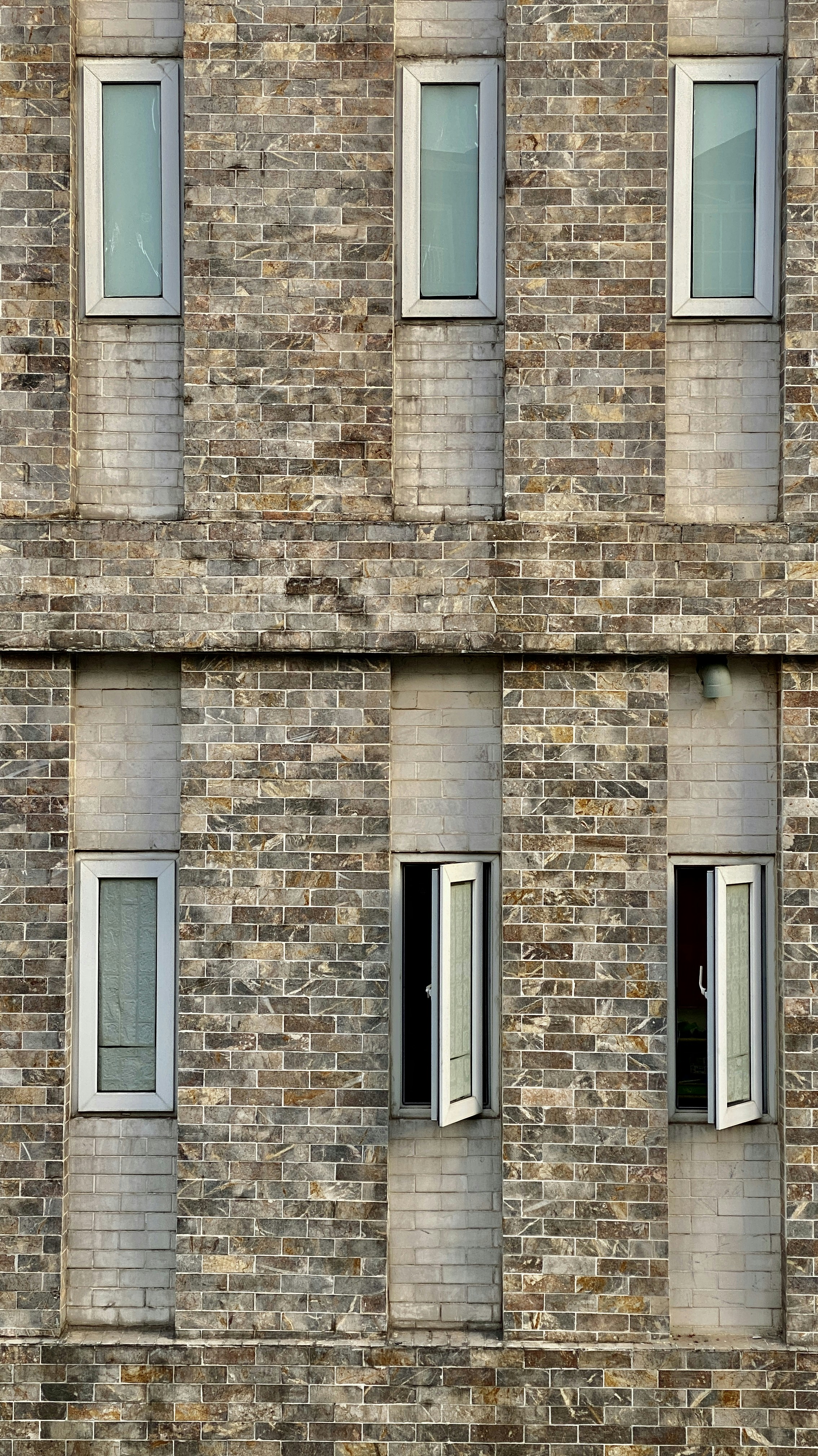 Vertical Windows Align in a Brick Facade: A Quiet Geometric Portrait