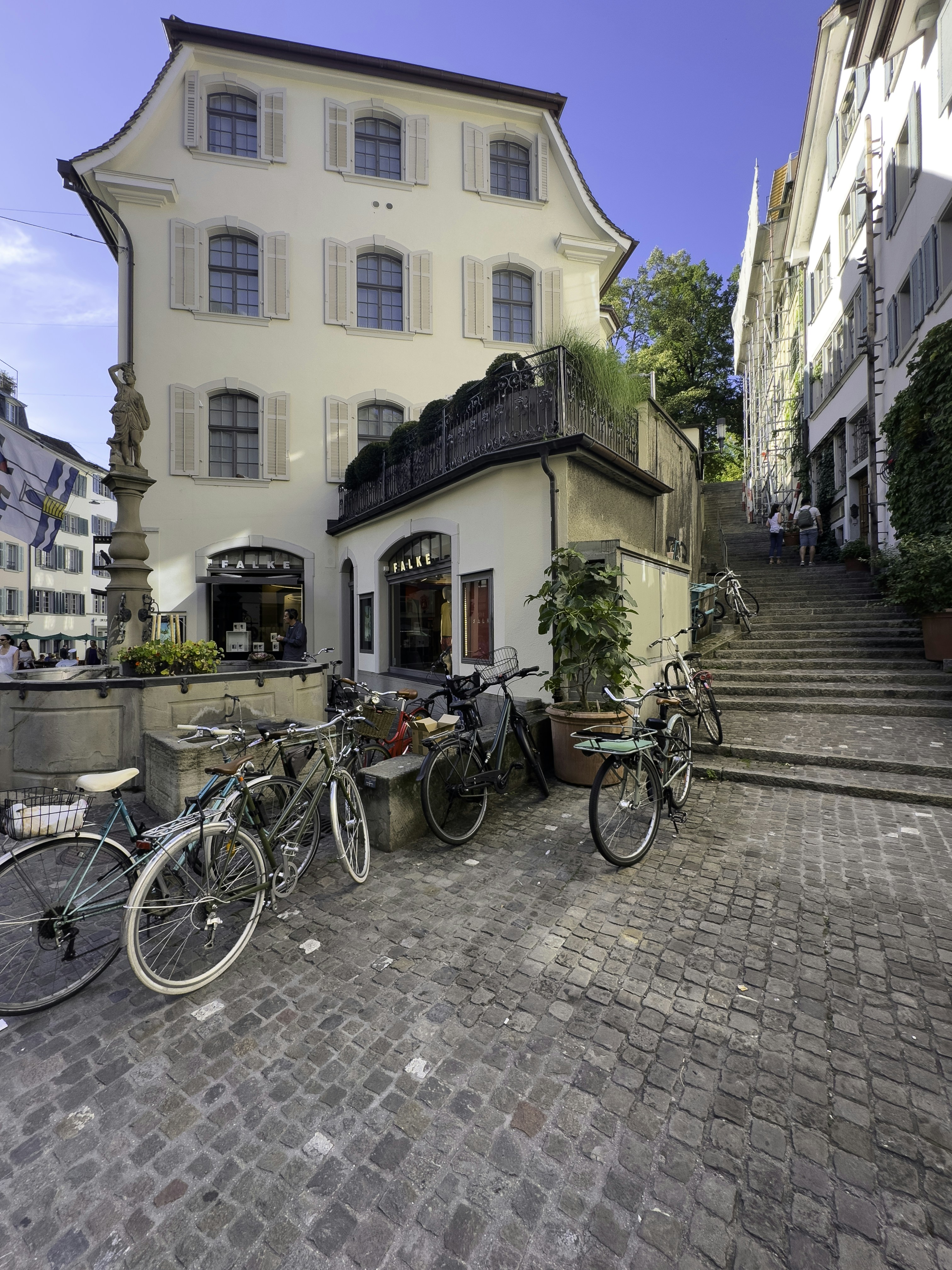 Cobbled Arcadia: Bicycles, Staircase, and a Café Facade