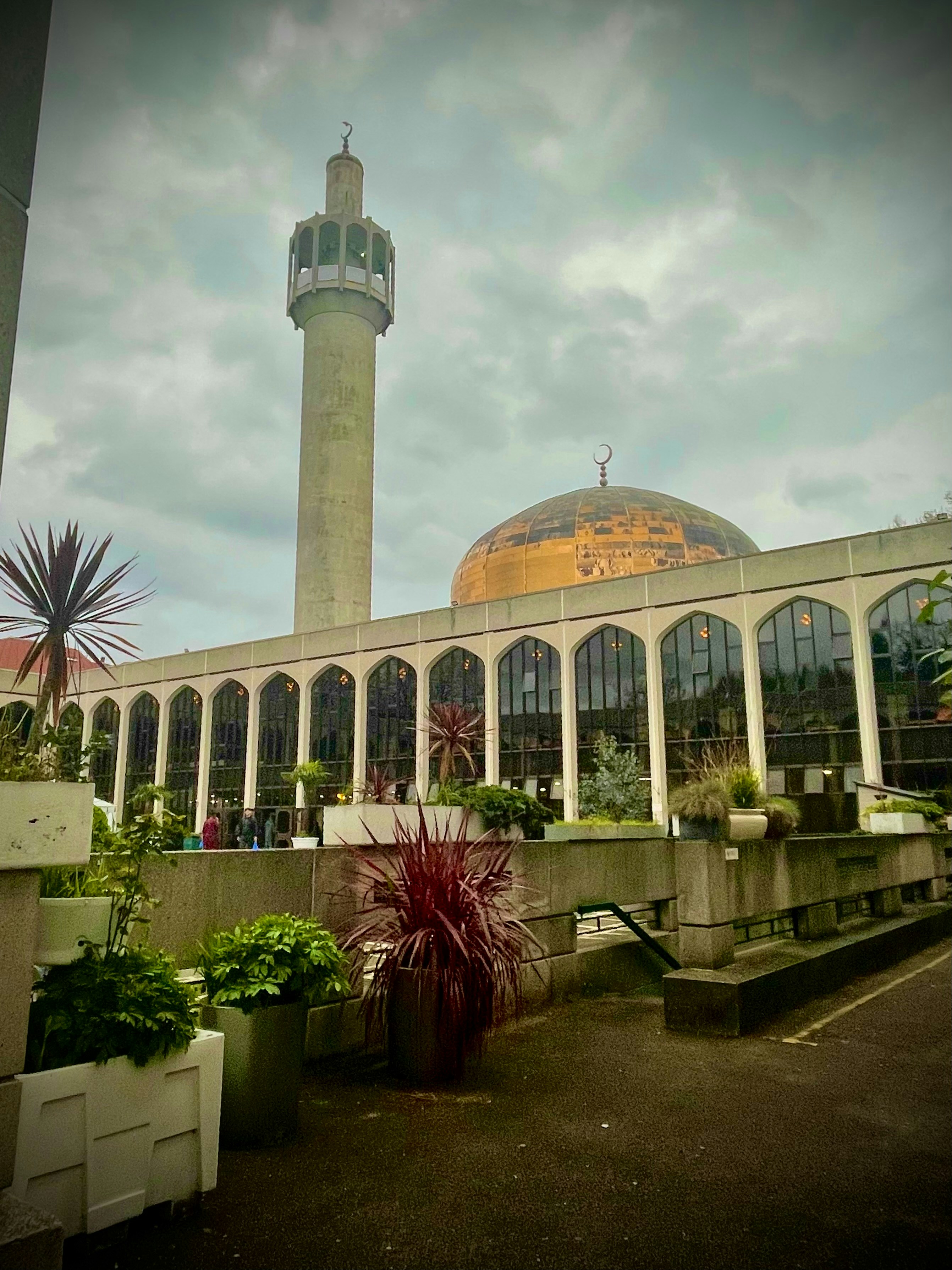 Echoes of Glass and Gold: Dome and Minaret Rise Over a Terraced Mosque Courtyard
