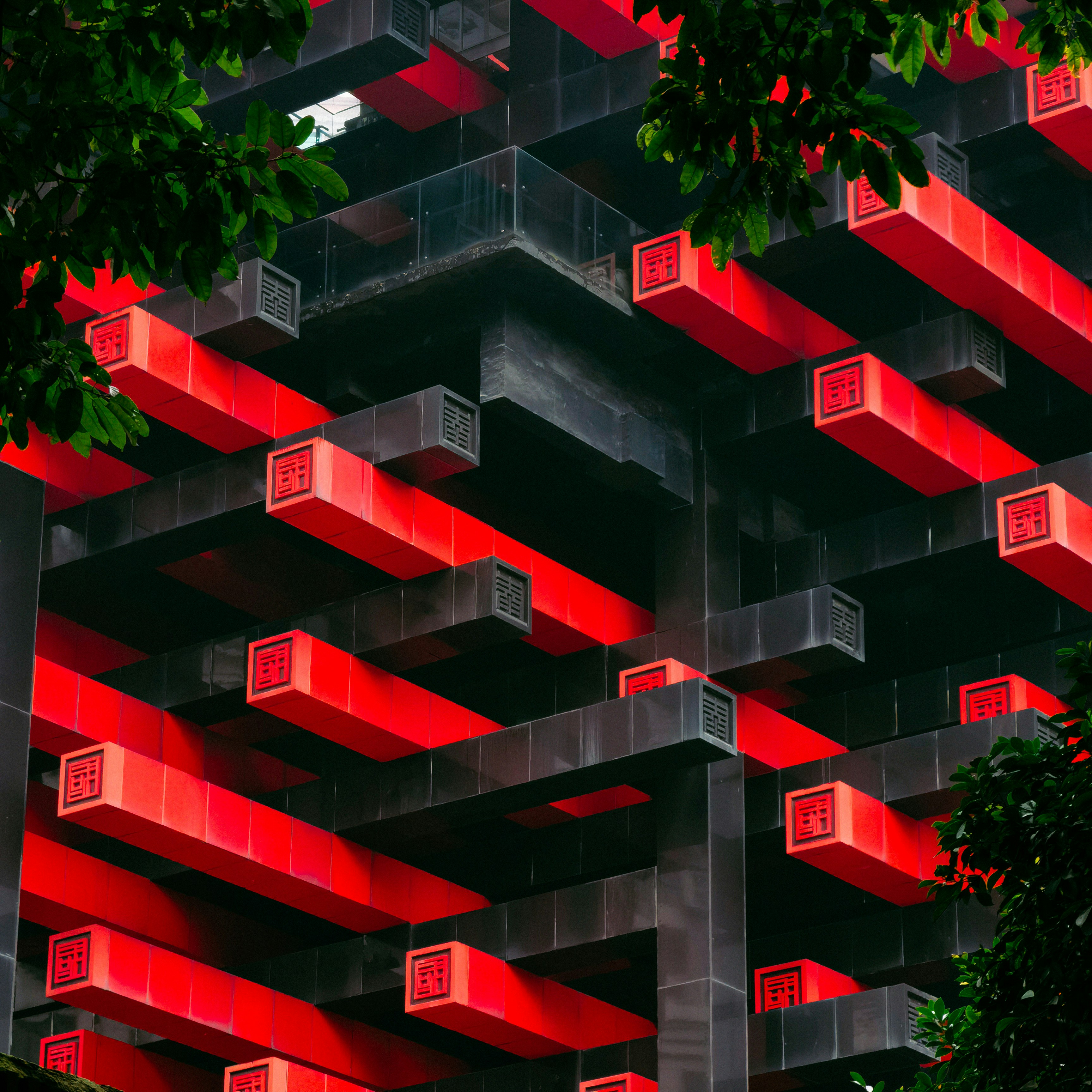 Crimson Cantilever Grid: Neon Balconies on a Shadowed Facade