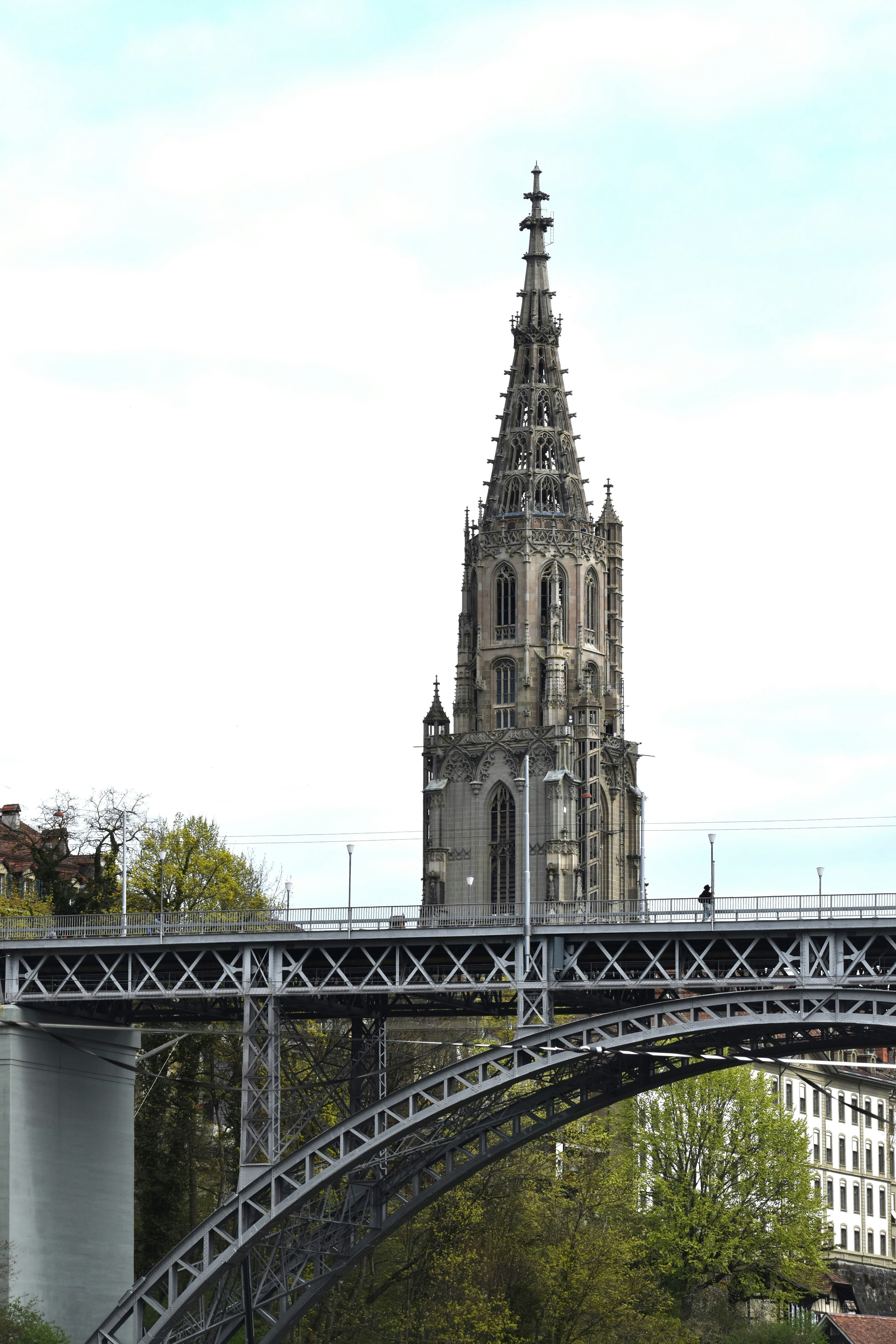 Spire Above the Iron Arches: Gothic Peak Over a City Bridge