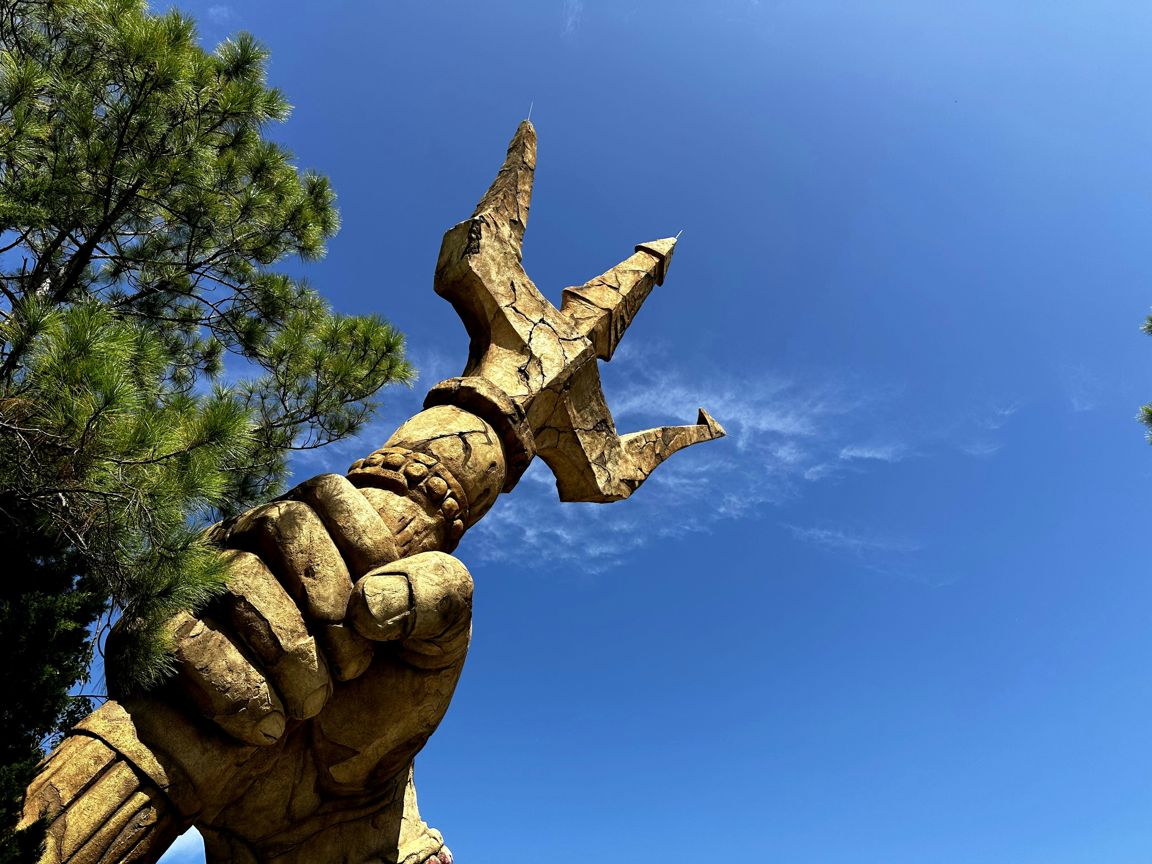 A statue of a hand reaching up into the sky photo – Free Universal ...