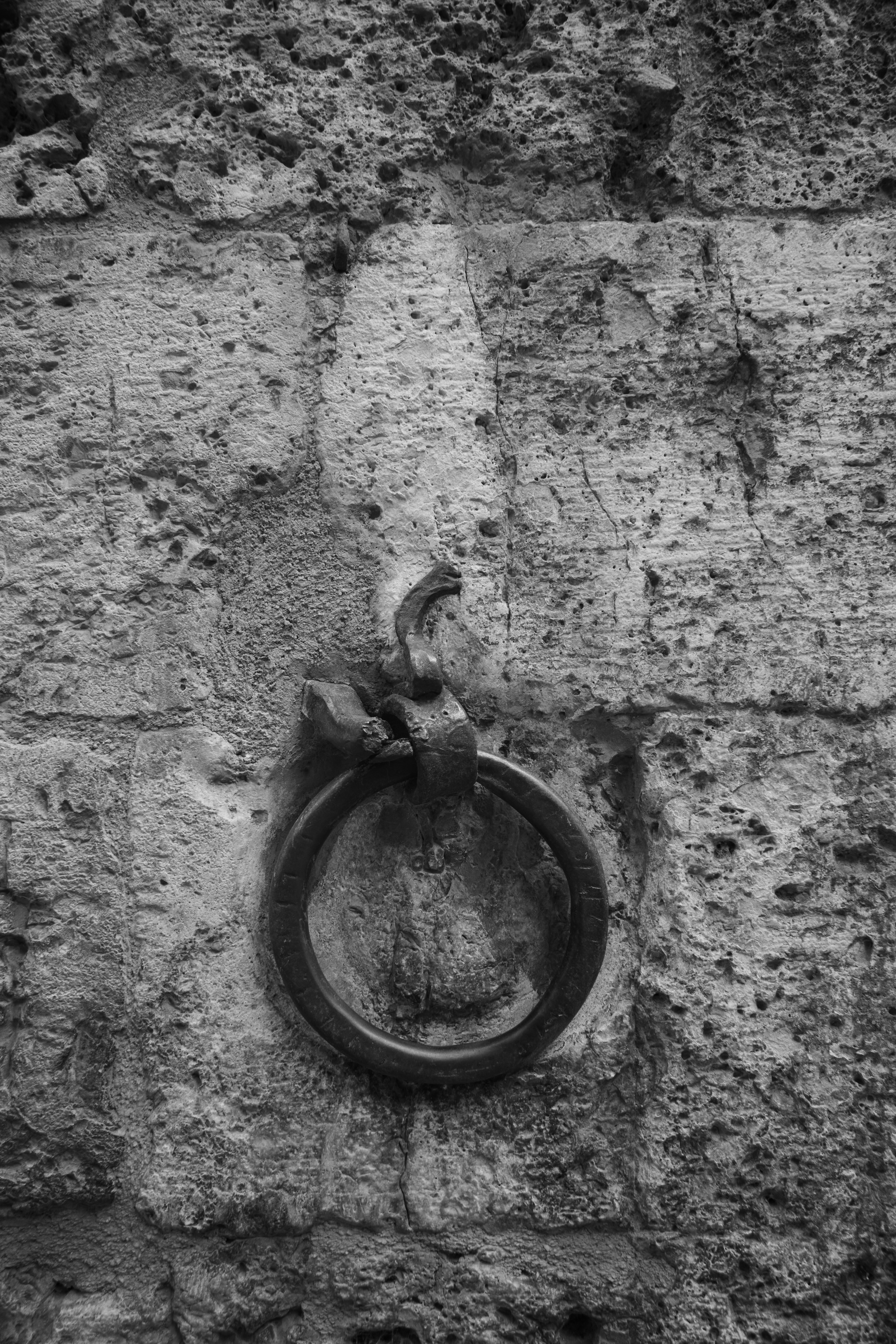 Weathered Ring: A Bronze Door Knocker in Silent Stone